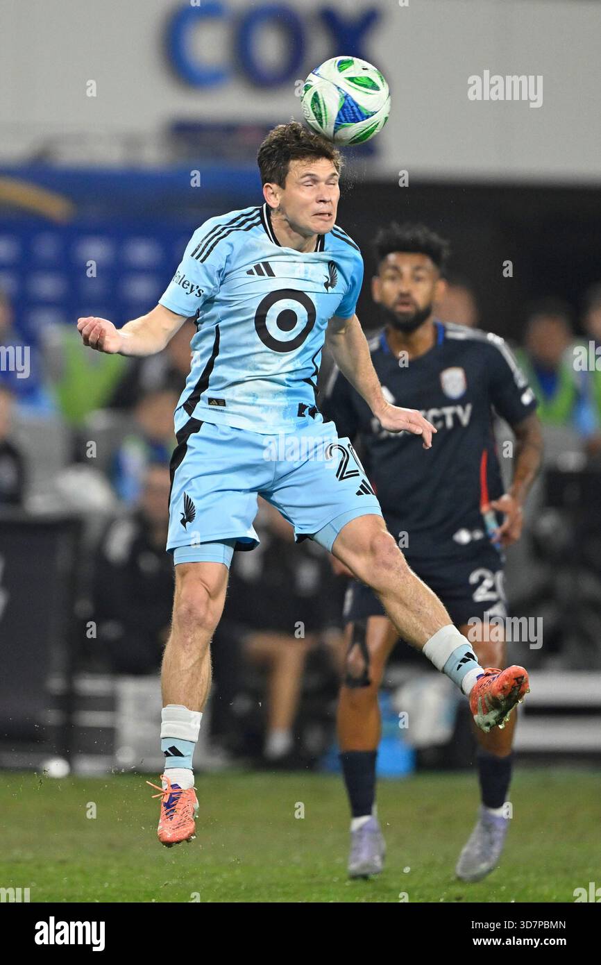 Minnesota United midfielder Will Trapp (20) heads the ball in front of ...
