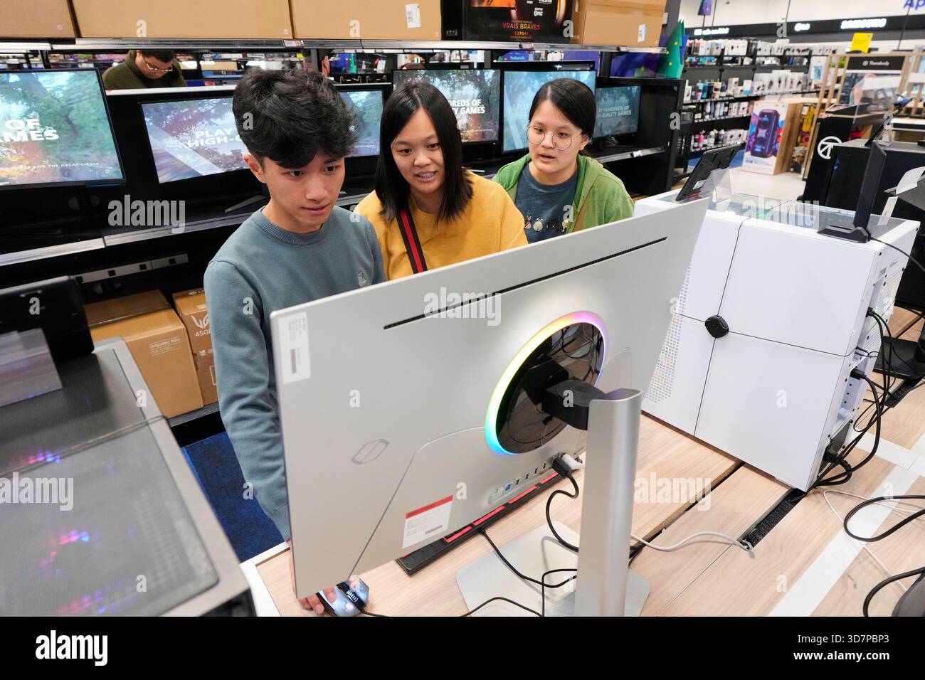 Jiang Lian Ng, from left, Caroline Leung and Chelsey Leung, right, look ...