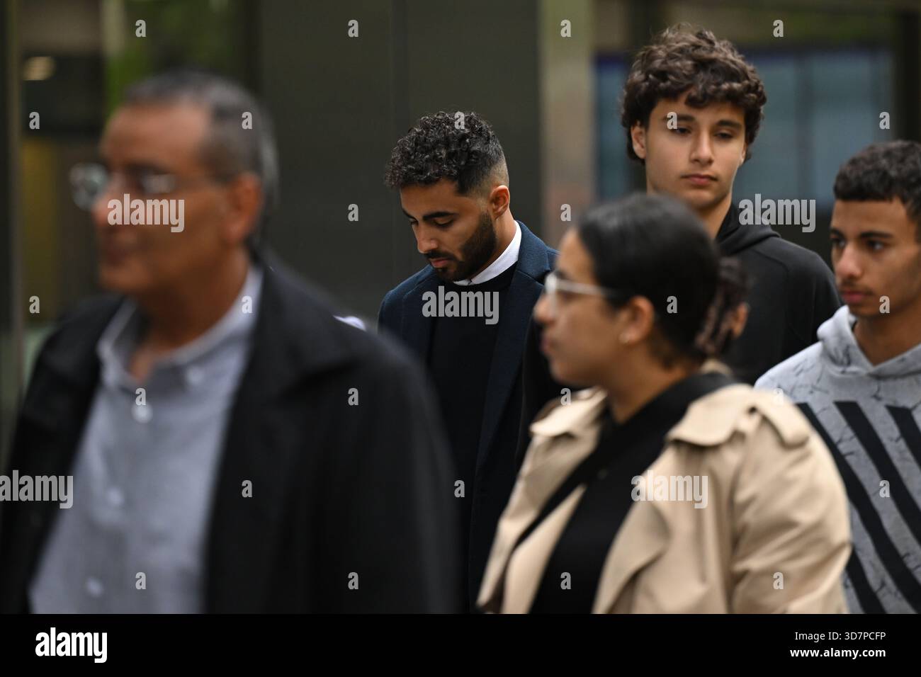 Kamal Ghali (centre) arrives to the County Court of Victoria, in ...