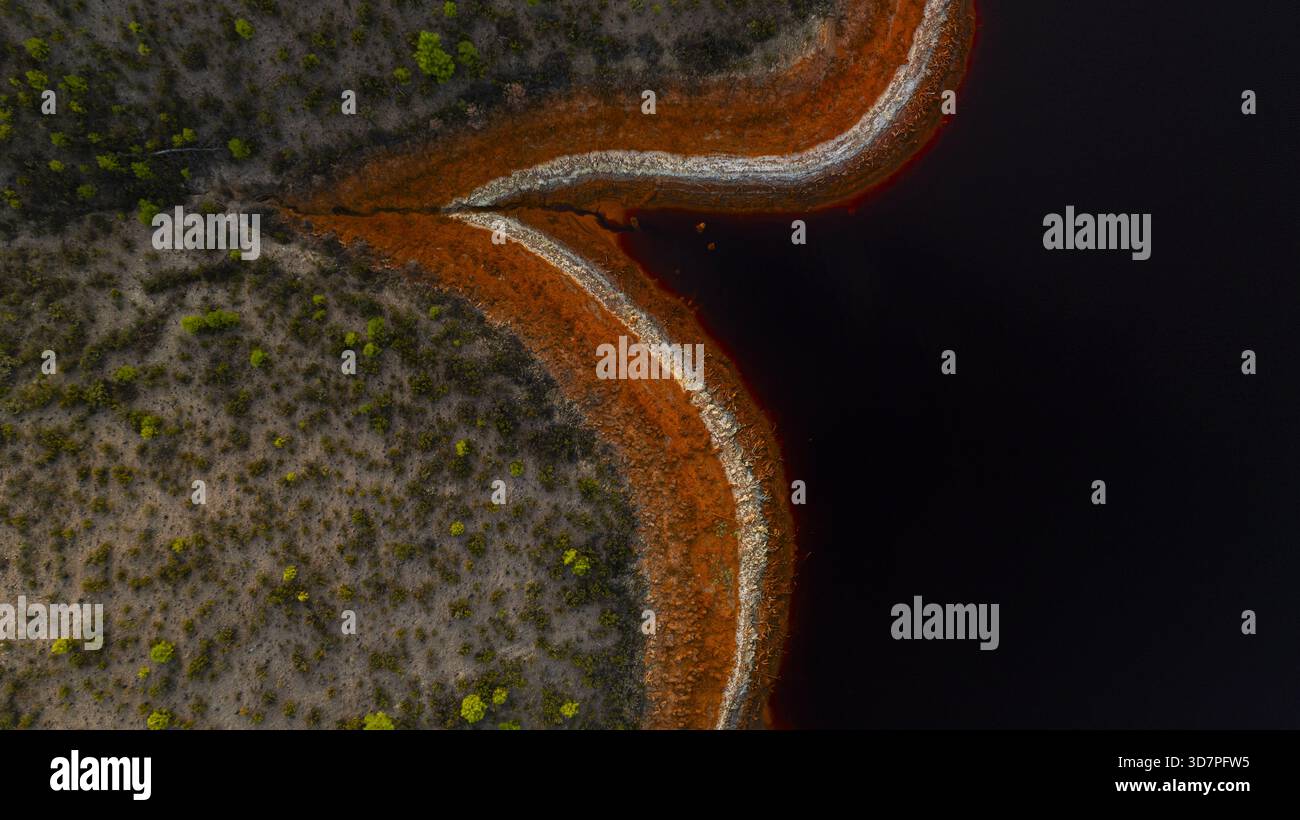 Aerial view of the stark contrast between the reddish-brown earth and ...