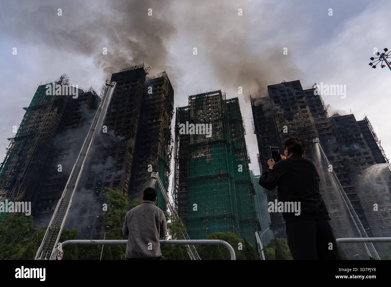 Firefighters work to extinguish a fire which broke out at Wang Fuk ...