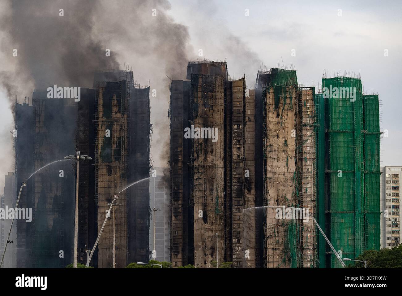 Firefighters work to extinguish a fire which broke out Wednesday at ...