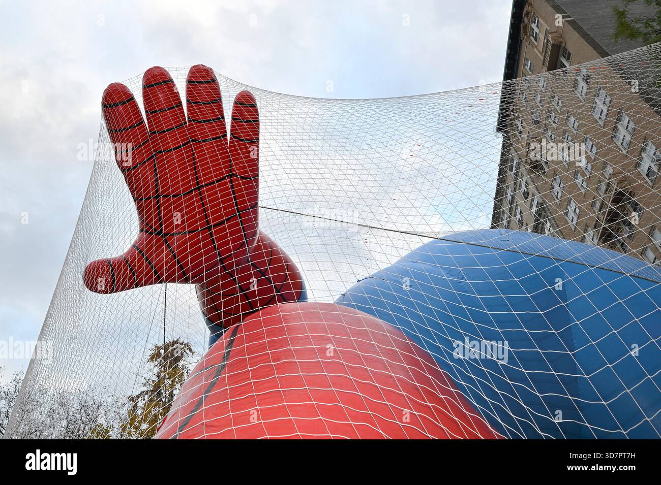 The Spiderman balloon rests under protective netting during Macy's ...
