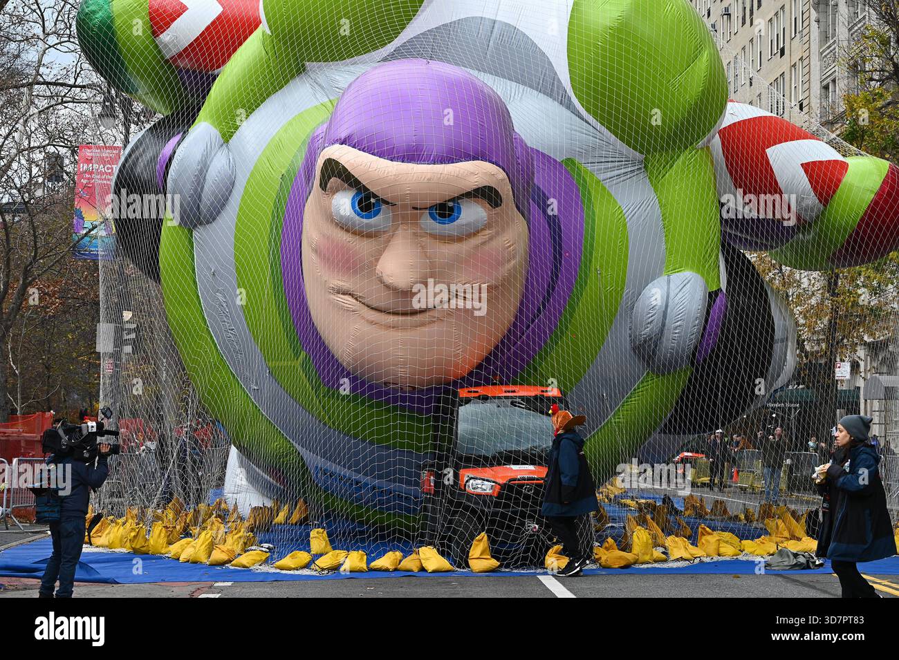 People walk near the new Buzz Lightyear balloon during Macy's Balloon ...