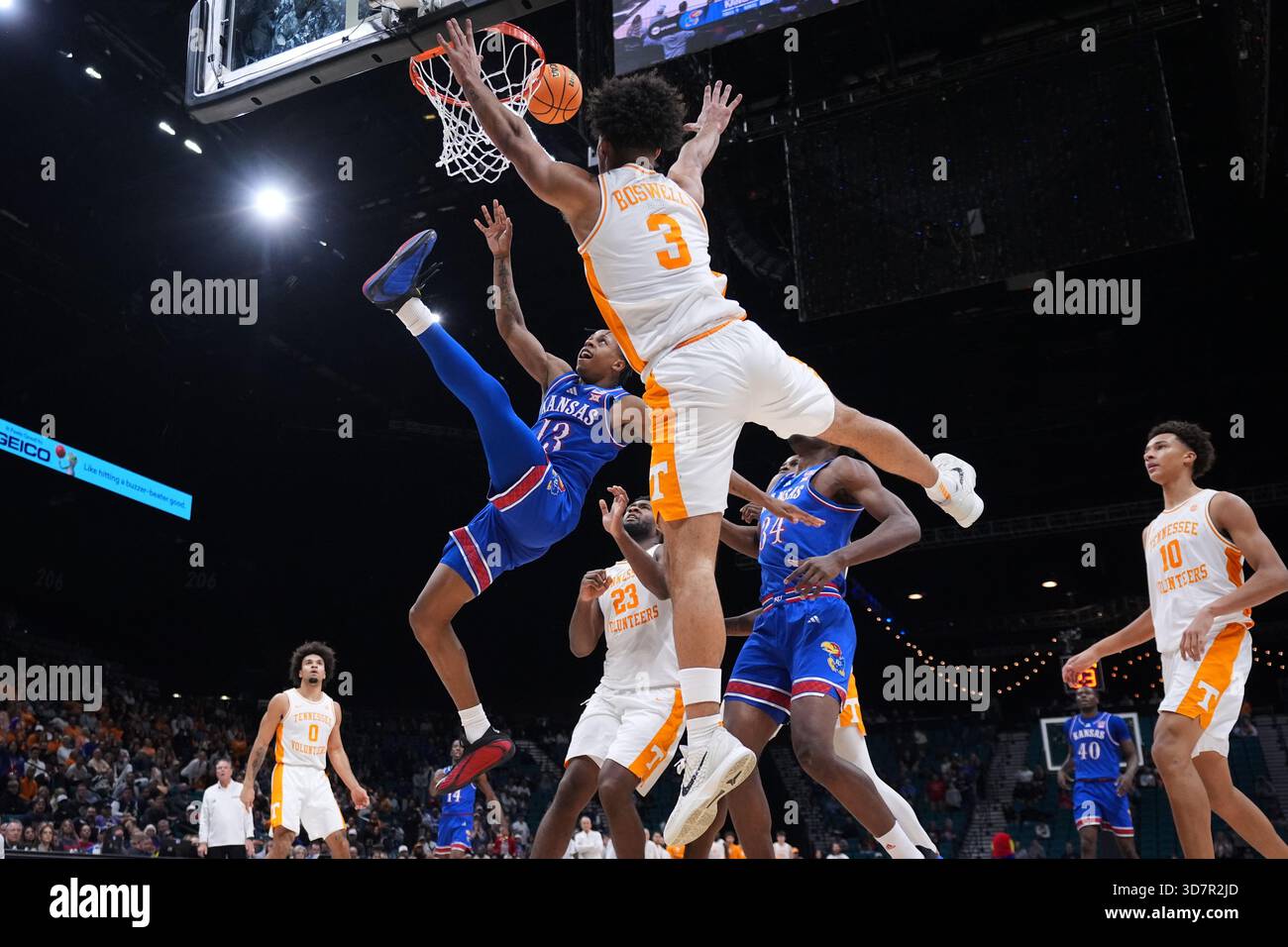 Kansas guard Elmarko Jackson (13) scores past Tennessee guard Bishop ...