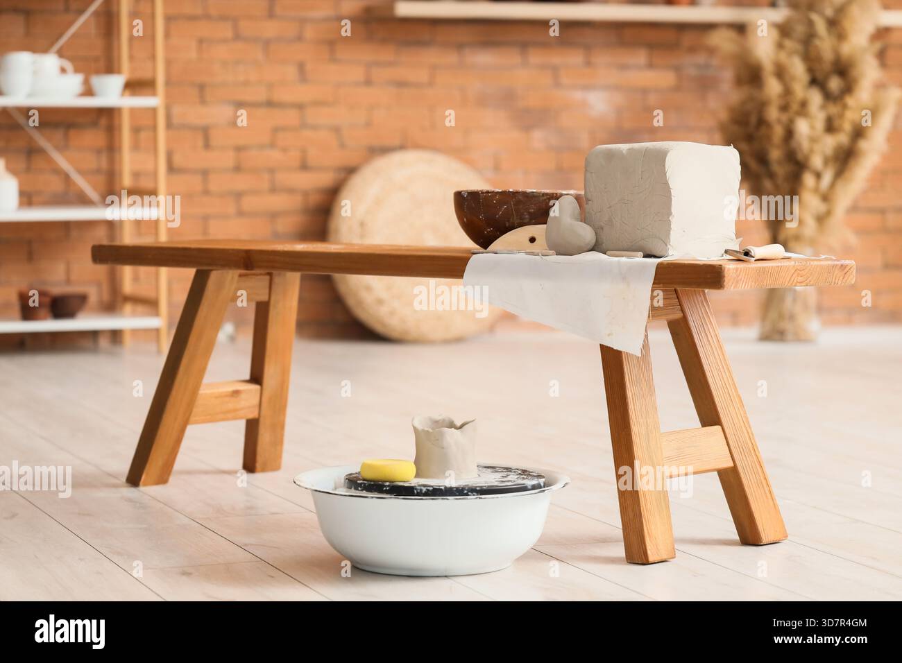 Clay block and pottery tools on bench in home studio Stock Photo - Alamy