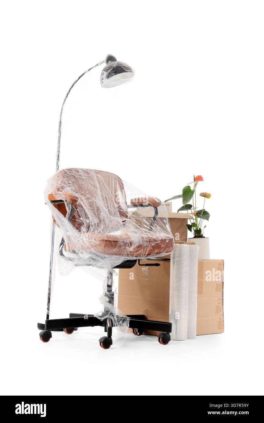 Office chair wrapped in stretch film and cardboard boxes on white ...