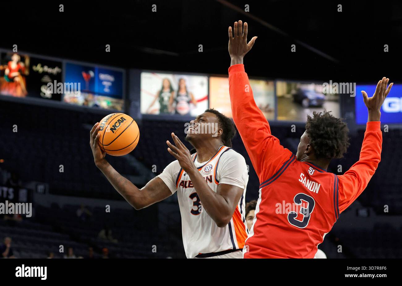 Auburn forward KeShawn Murphy, left, heads to the basket past St. John ...