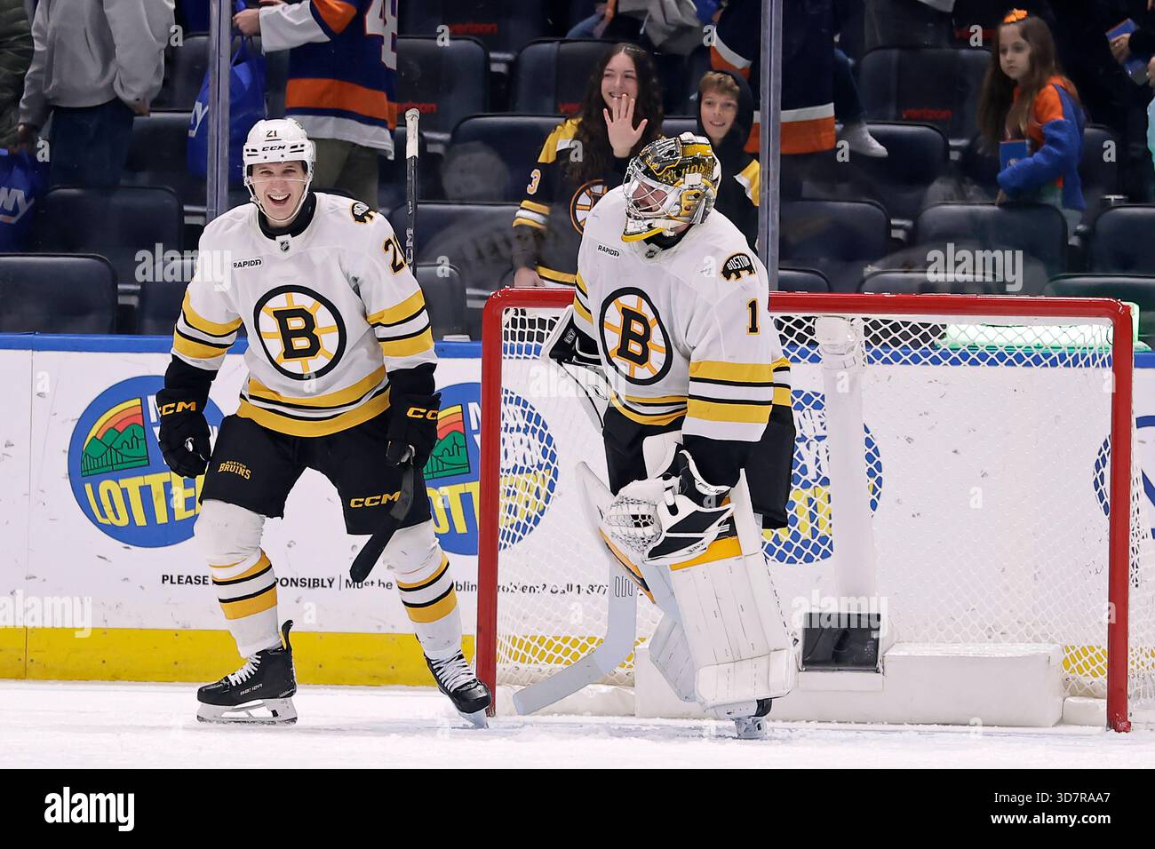 Boston Bruins goaltender Jeremy Swayman, right, and center Alex Steeves ...