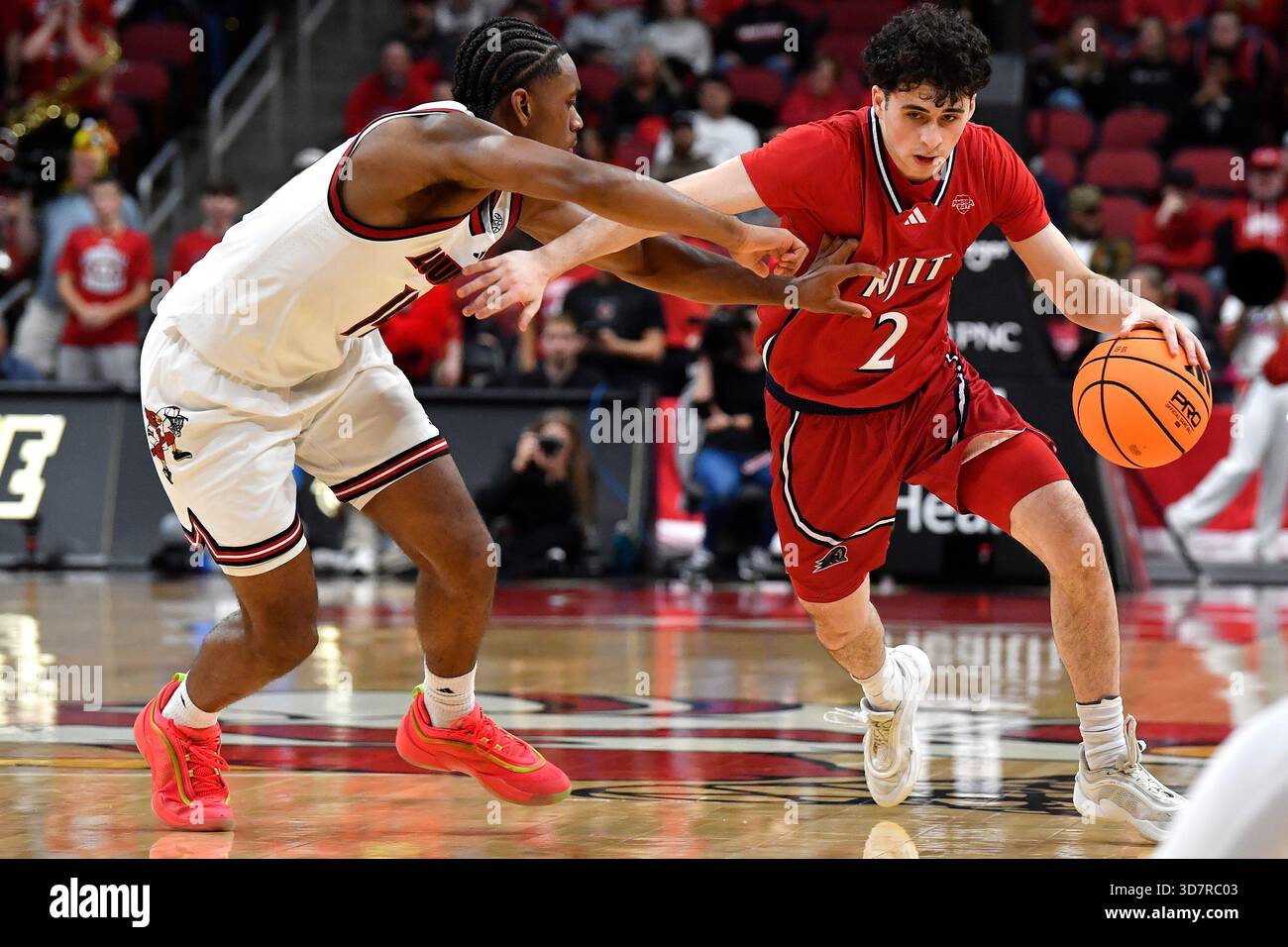 NJIT guard Jeremy Clayville (2) drives against Louisville guard Adrian ...