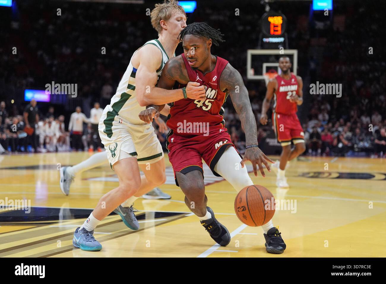 Miami Heat guard Davion Mitchell (45) drives past Milwaukee Bucks guard ...