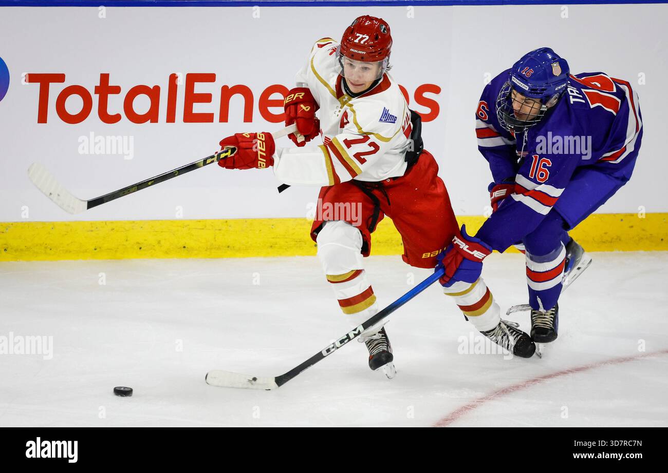 Team USA's Parker Trottier, right, checks Team CHL's Xavier Villeneuve ...