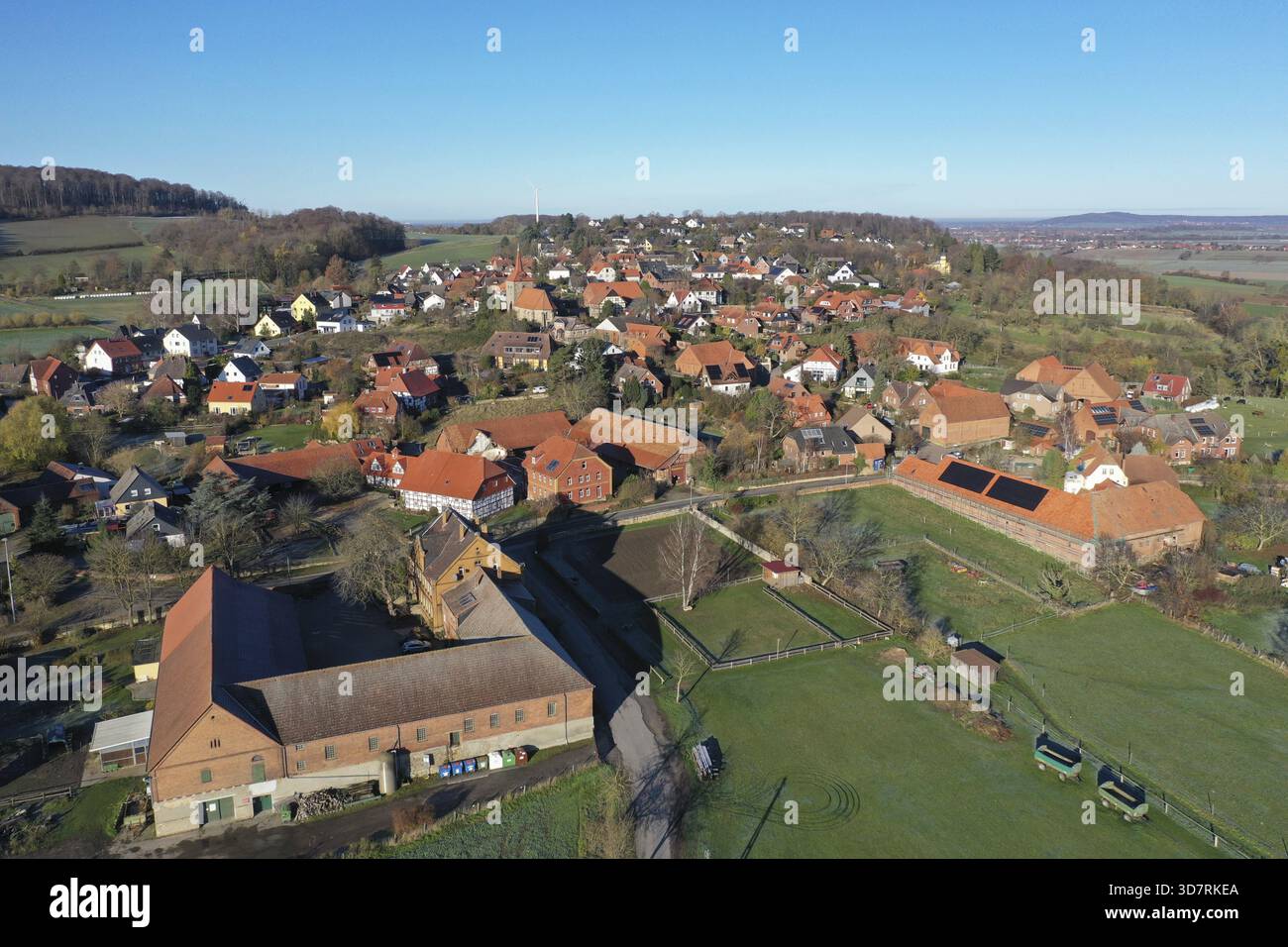 Aerial view of Luedersen mountain village, large farms in front, three ...