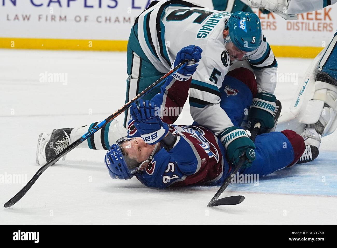 San Jose Sharks defenseman Vincent Desharnais lands on Colorado Avalanche center Nathan ...