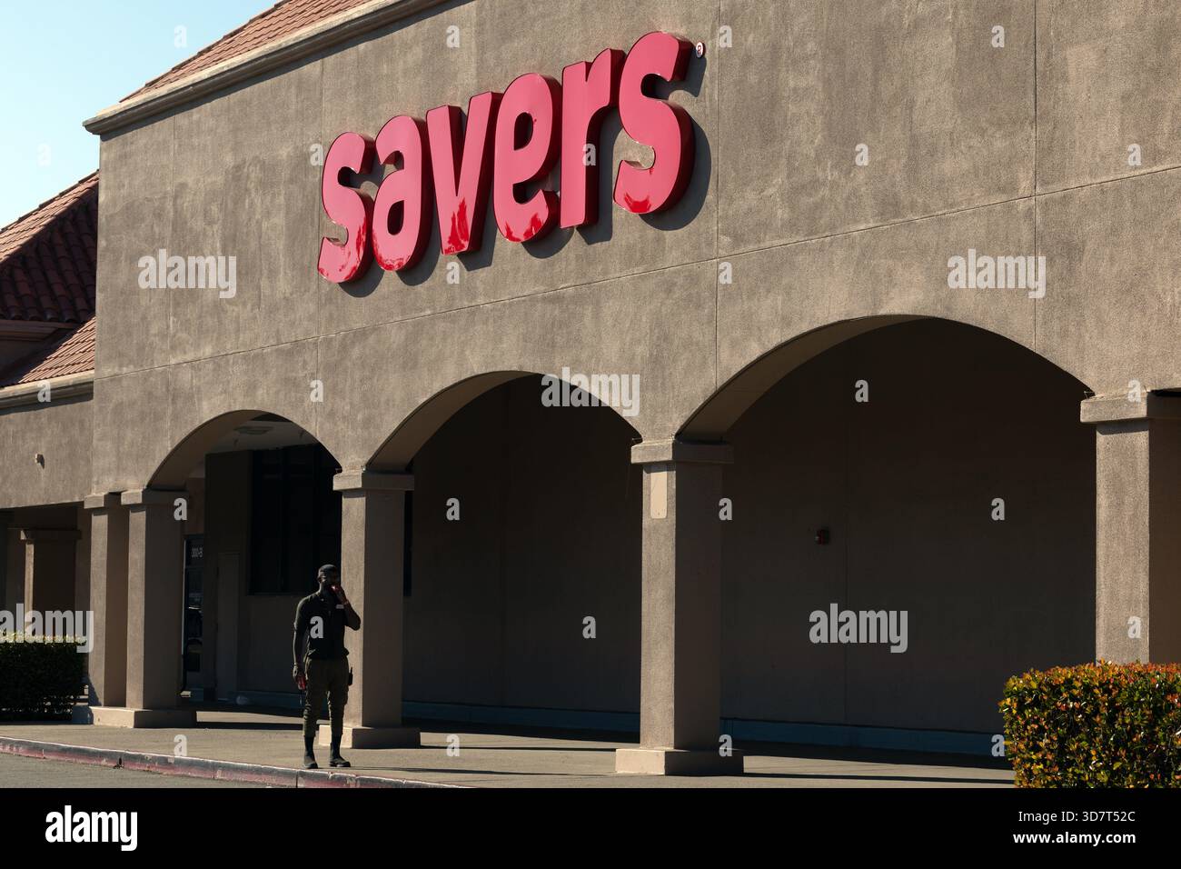 Savers Thrift Store Exterior with Person Walking Past Stock Photo - Alamy