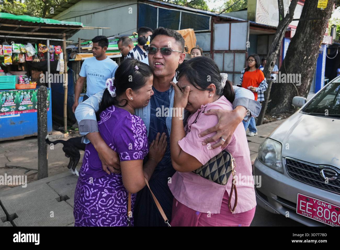 A man, center, released from Insein prison, is welcomed by family ...