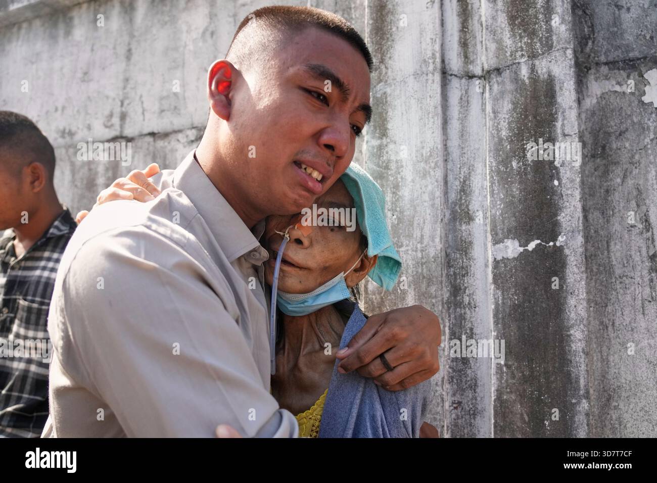 A boy, released from Insein prison, is welcomed by a family member in ...