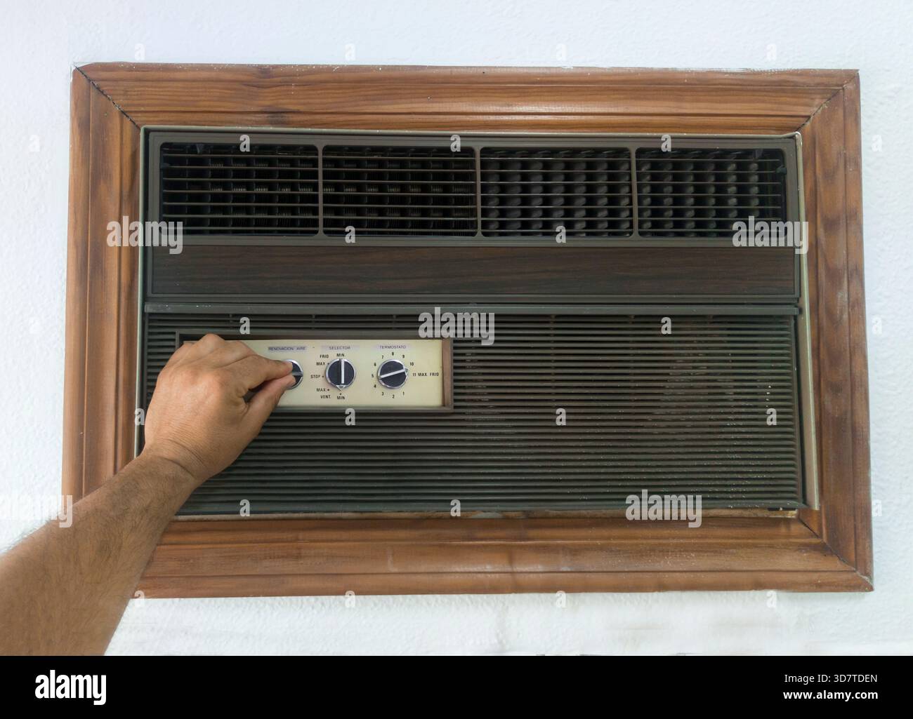 Adjusting old conditioner temperature. Hand directly turning the split ...