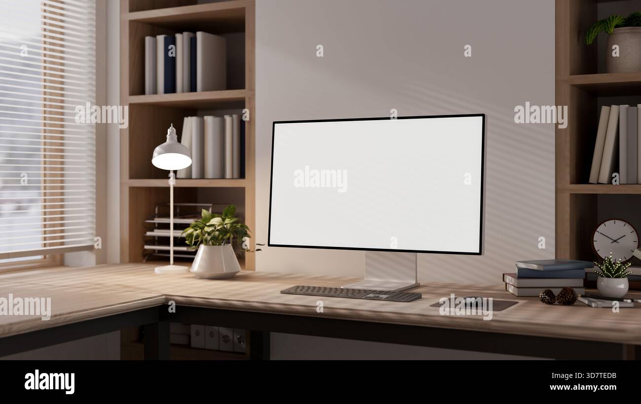 Blank screen computer with a lamp and books on wooden table in a room ...