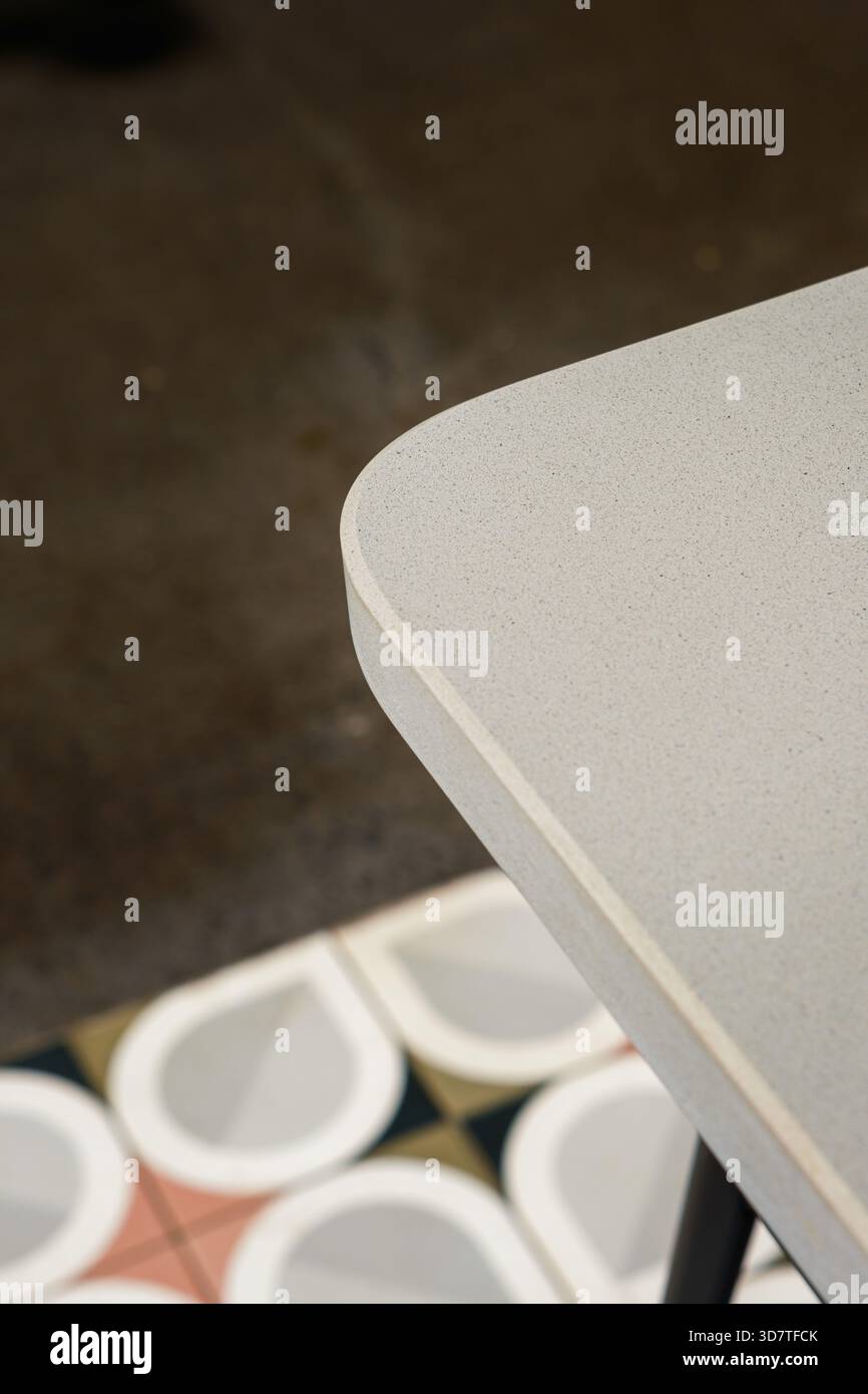 Smooth curve. Close-up of a light grey speckled surface with a rounded ...
