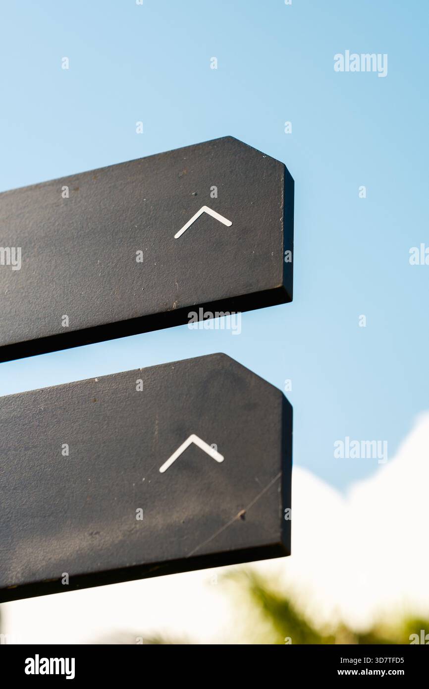 Pointing the way. Simple, minimalist design of two dark signs featuring ...