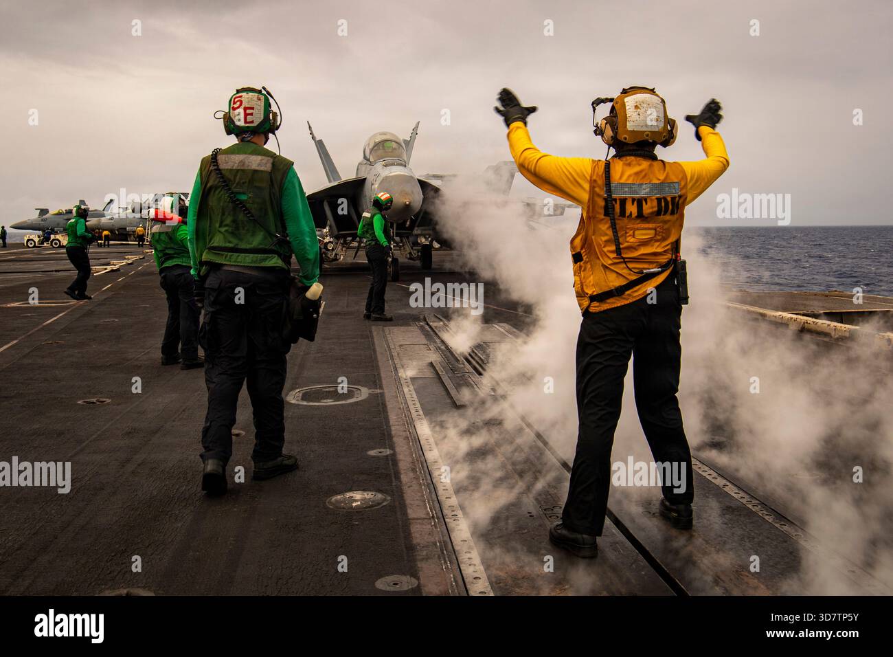 251125-N-FJ237-1191 U.S. Sailors direct an E/A-18G Growler, attached to the “Cougars” of ...
