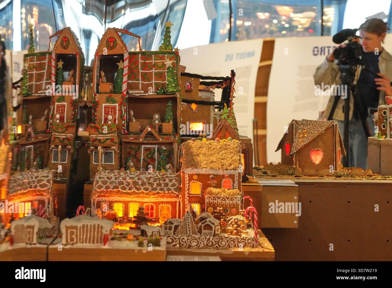 A journalist films buildings made of gingerbread at the exhibition 'The ...