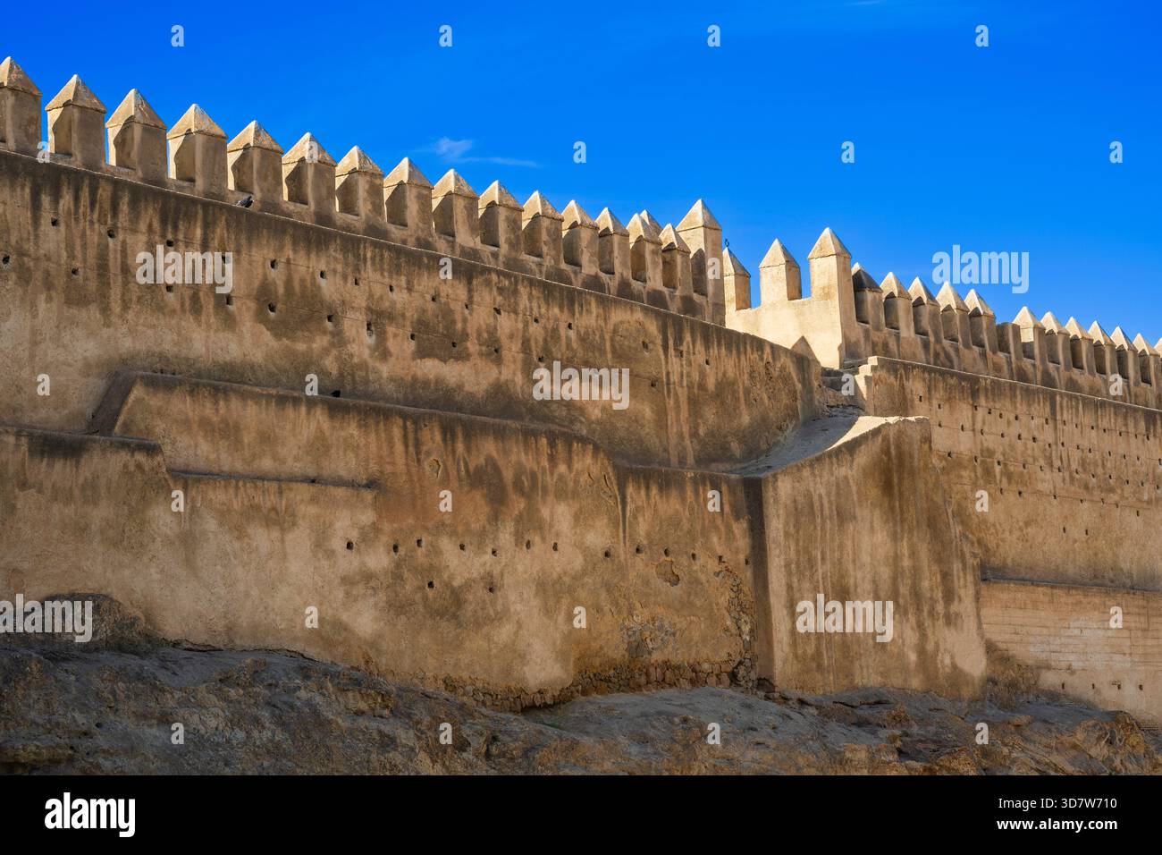 Historical stone fortress towers under a clear blue sky with ...