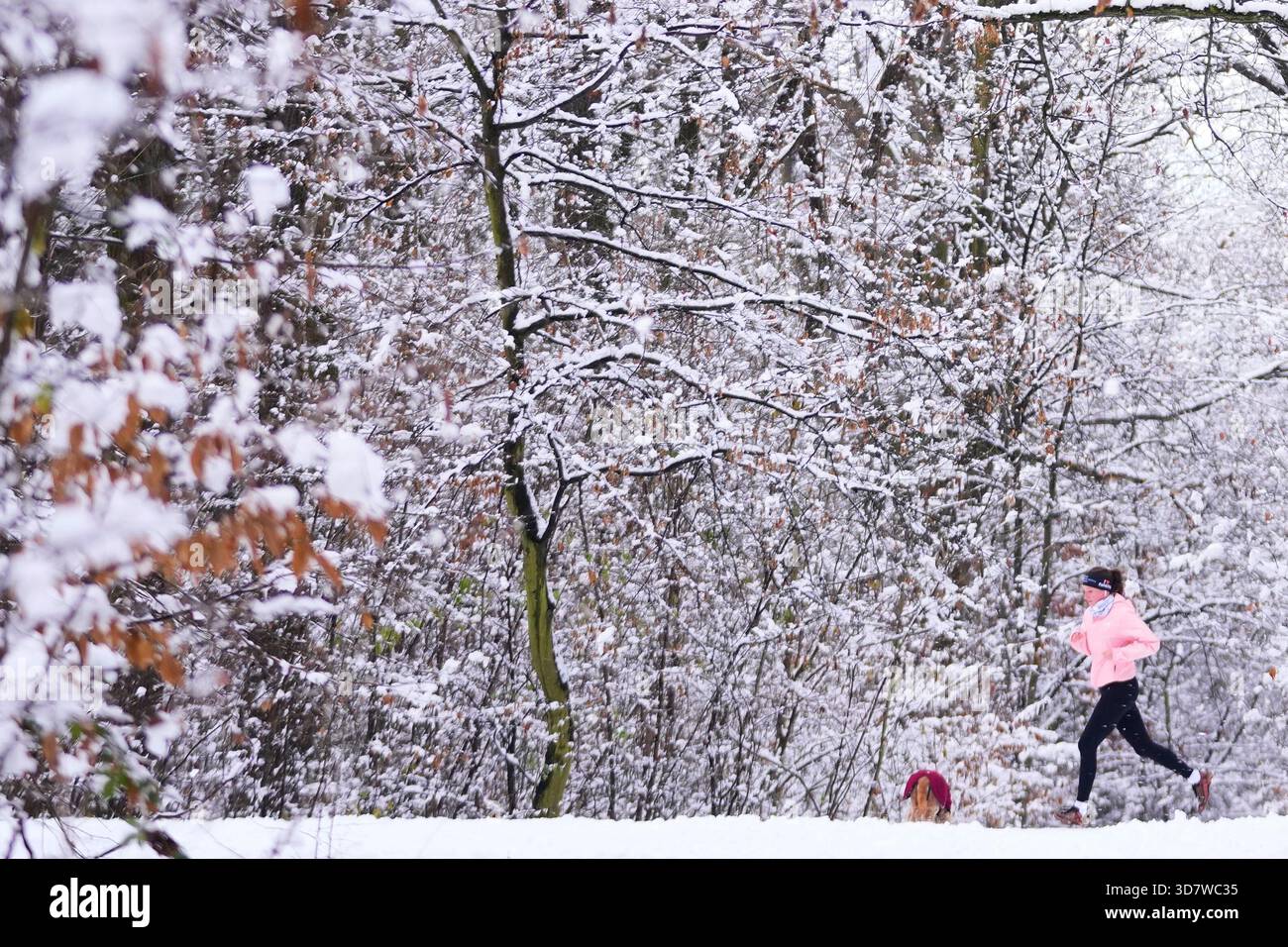 A woman runs after a snowfall in Prague, Czech Republic, Thursday, Nov ...