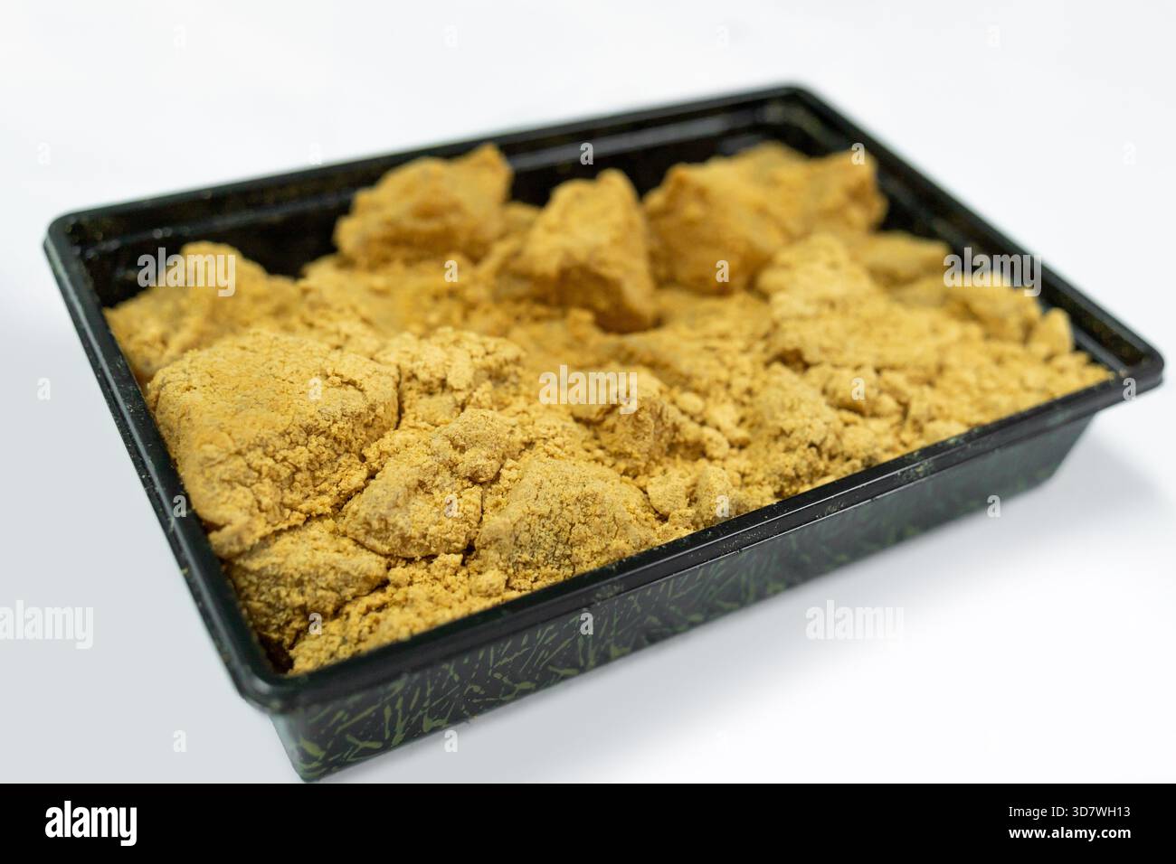 A tray of soft and jelly-like warabi mochi coated generously with ...