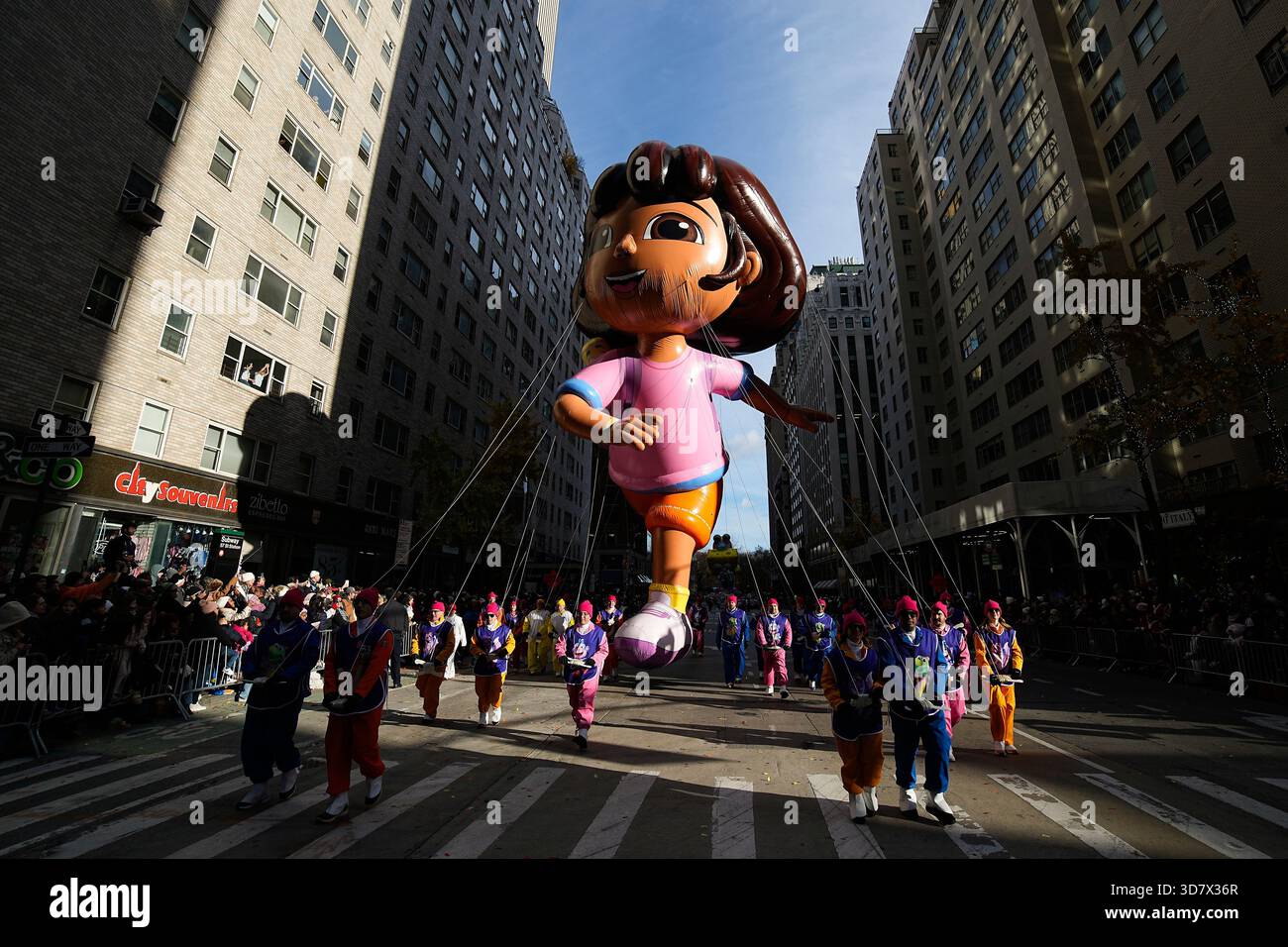 Balloon handlers guide the Dora balloon down Sixth Avenue during the ...