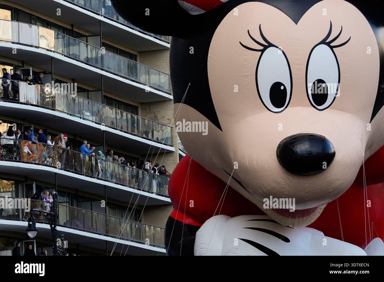 Spectators watch from their balconies as the Minnie Mouse balloon ...