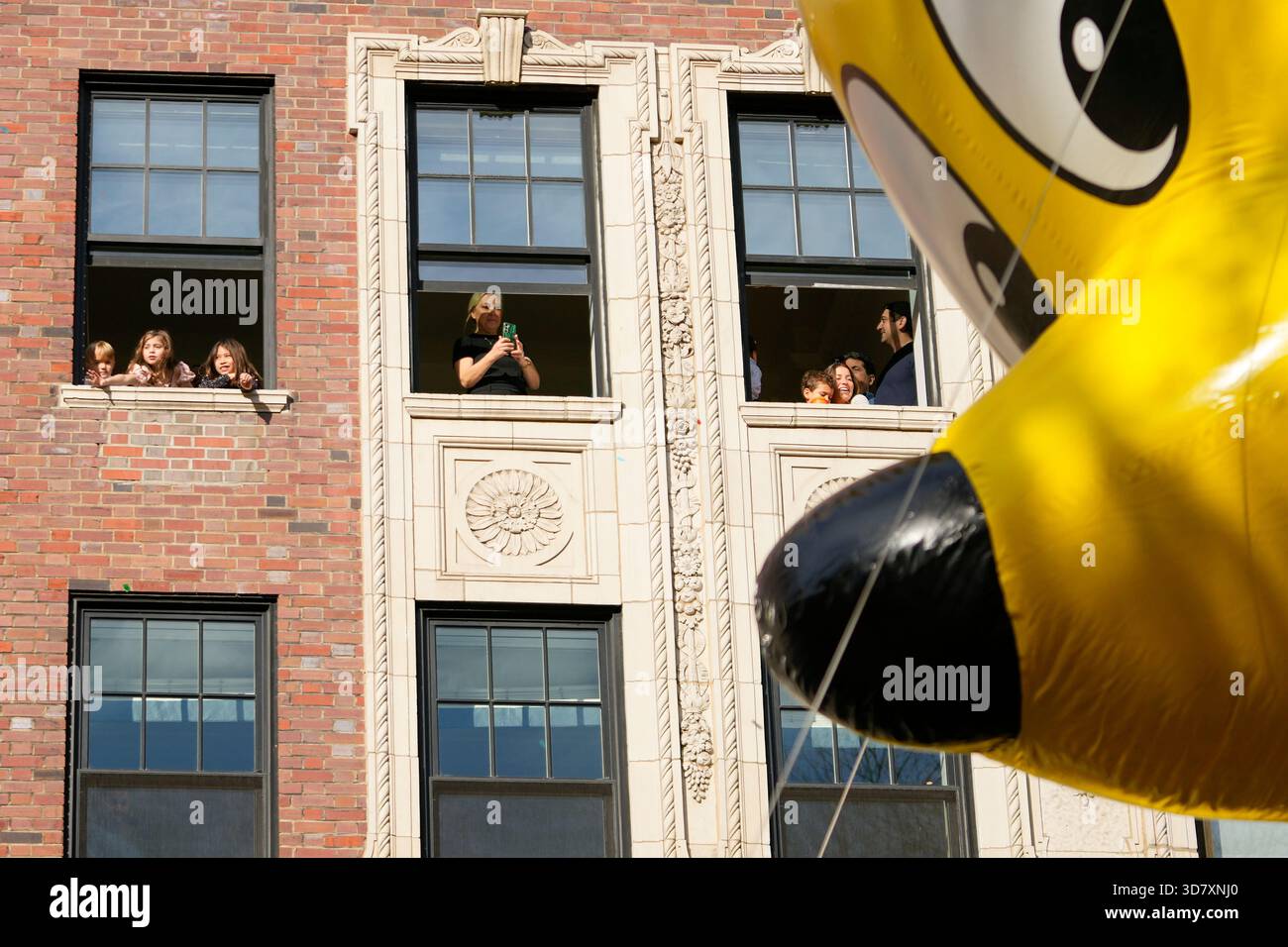 Spectators watch from their apartment windows as the Goldbear balloon ...