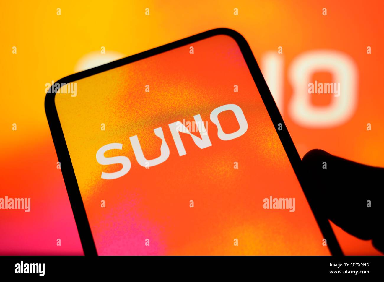 In this photo illustration, the Suno logo is displayed on a cell phone ...