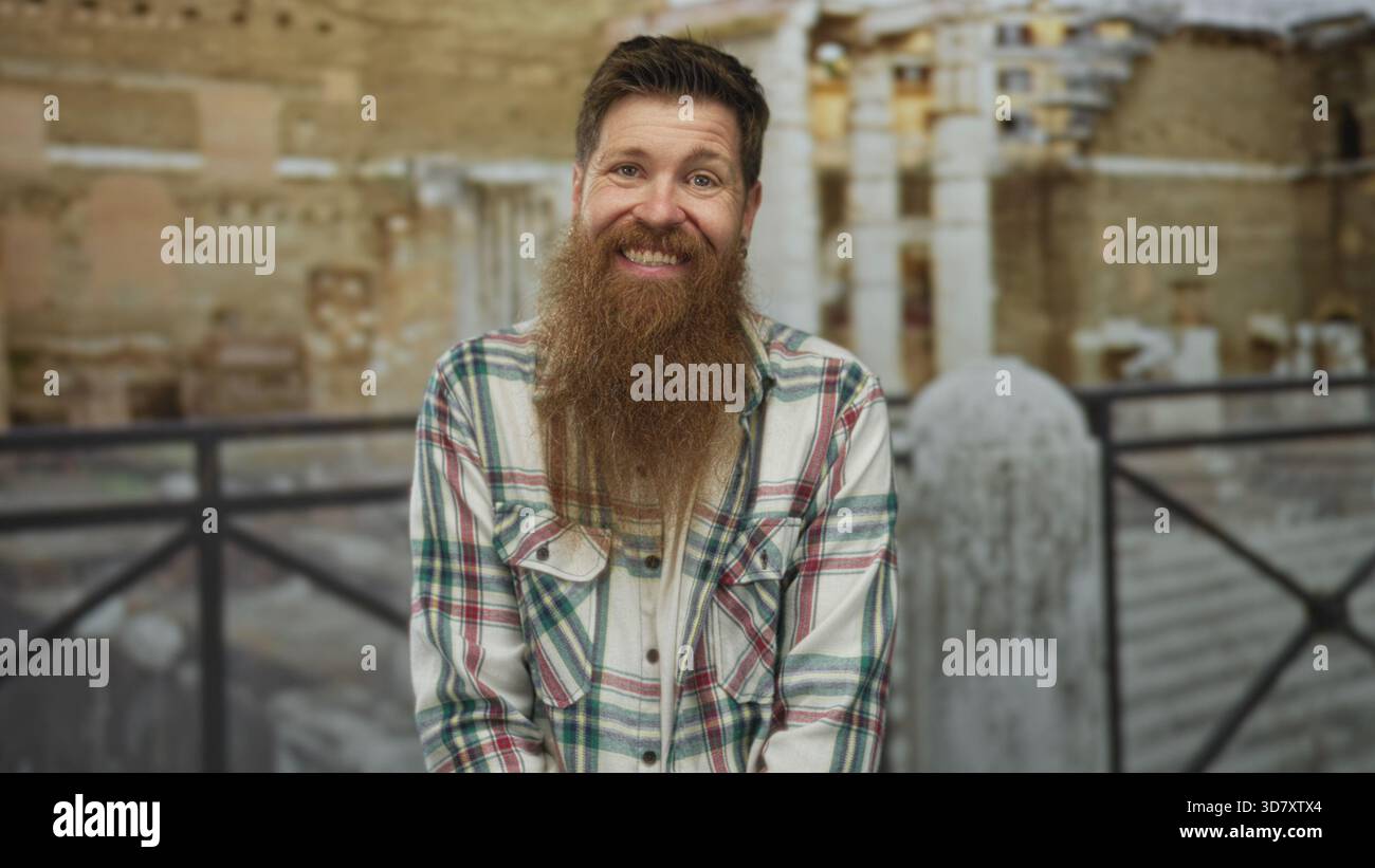 Bearded man gently smiles at ancient roman building through iron ...