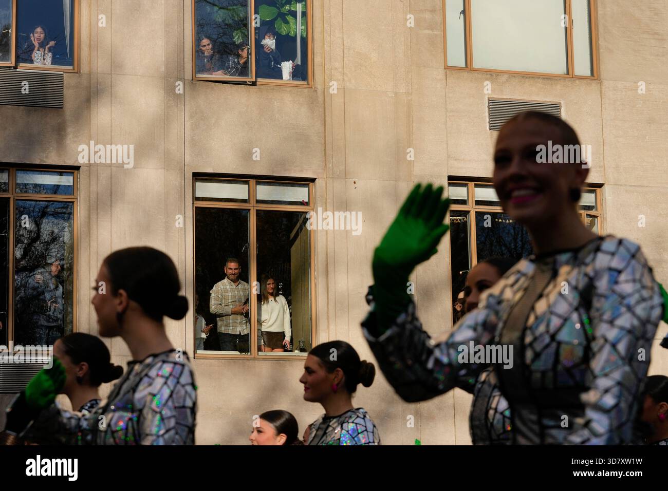 Spectators watch from their apartment windows as the Macy's ...
