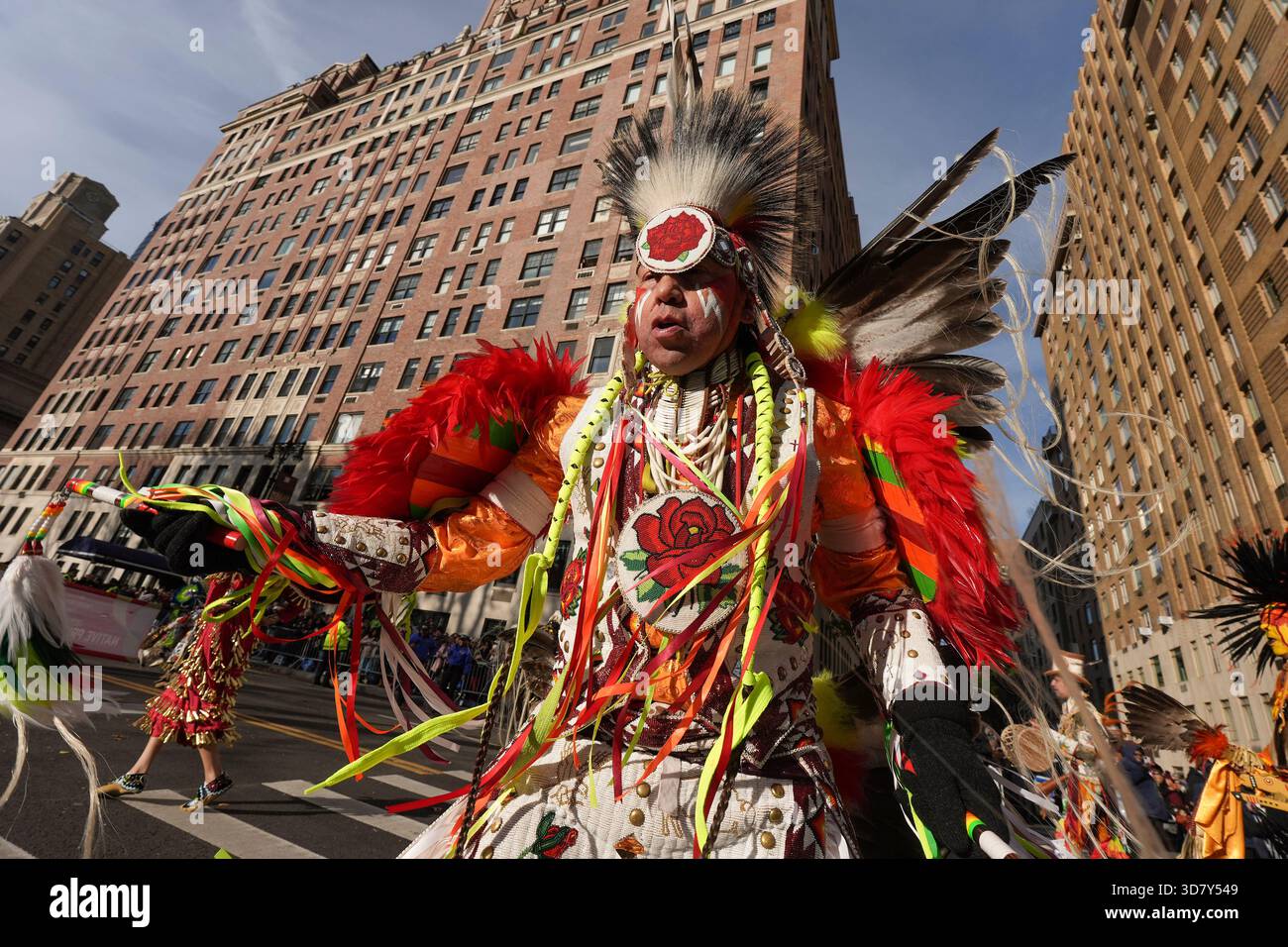 A performer with Native Pride Productions dances as he makes his way ...