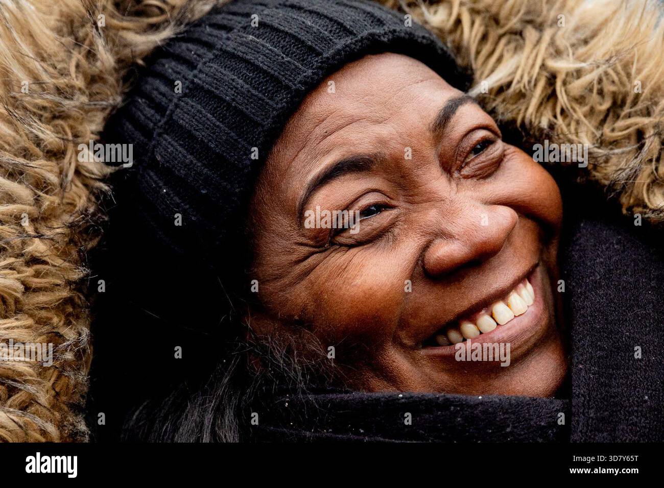 Portia Titus, 63 of Detroit, smiles as she watches floats go by in ...