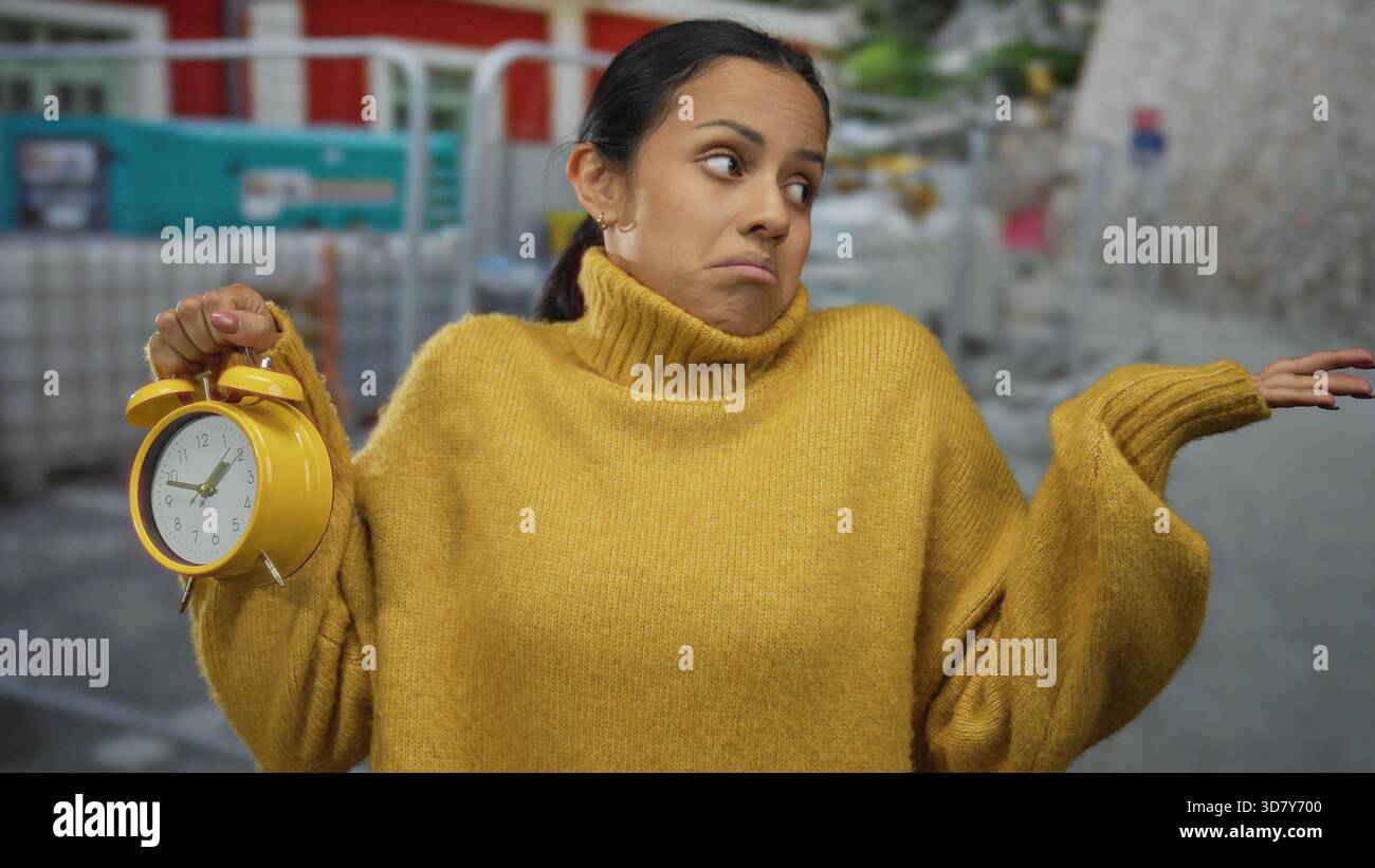 Woman shrugging yellow alarm hi-res stock photography and images - Alamy