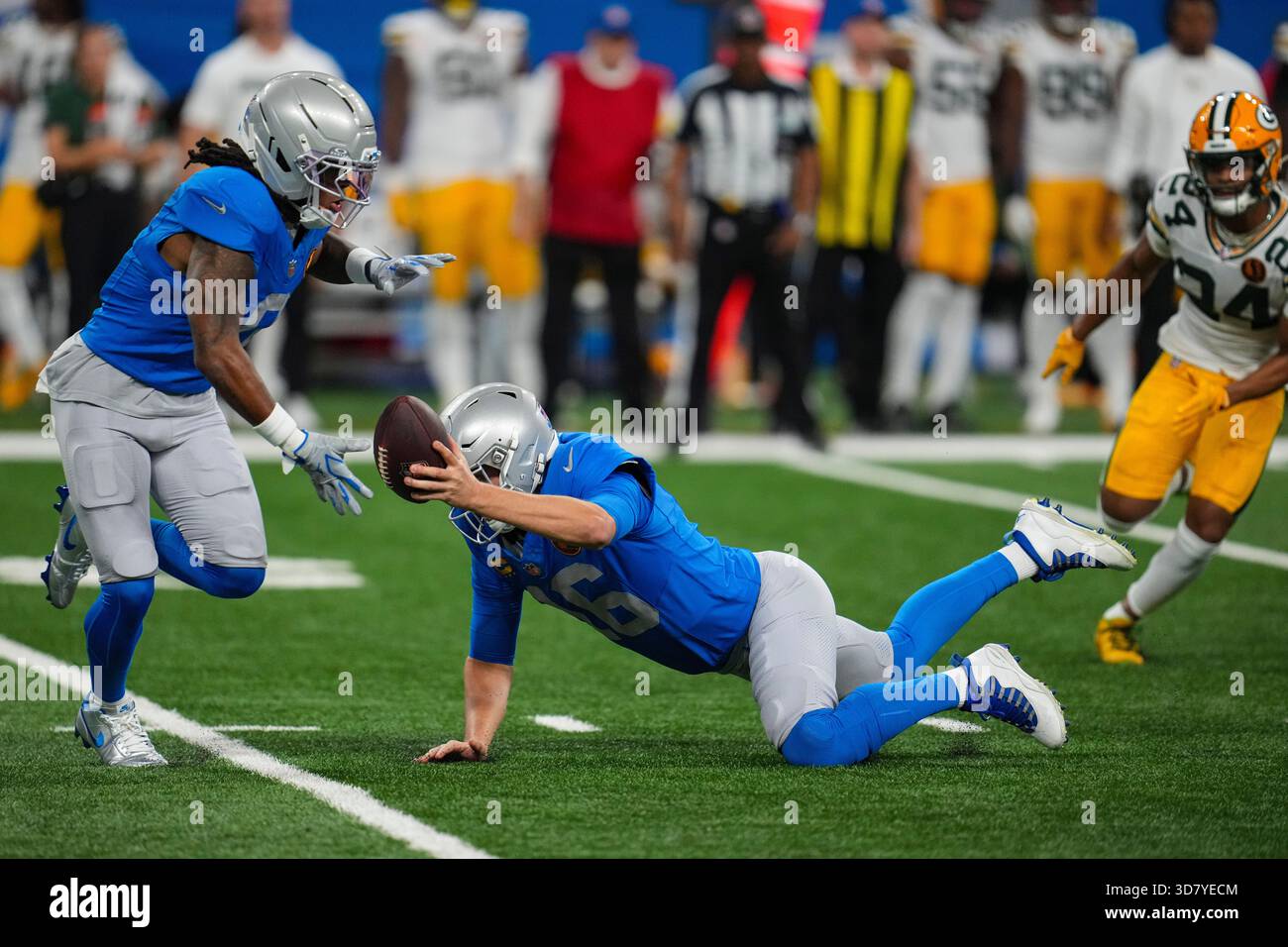 Detroit Lions quarterback Jared Goff (16) falls as he hands off to ...