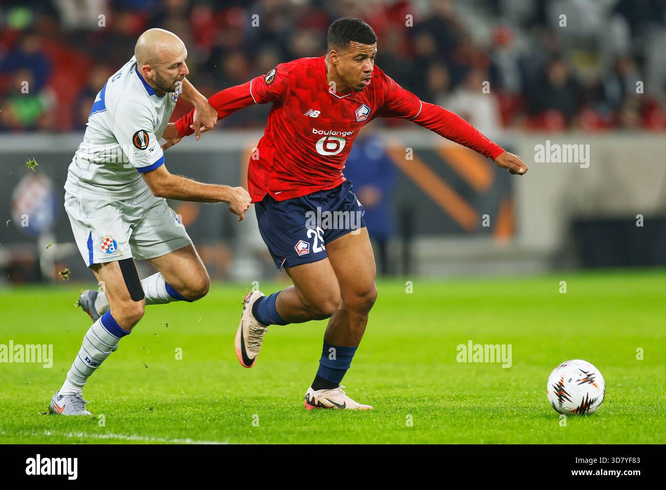 Dinamo's Josip Misic, left, challenges for the ball with Lille's Hamza ...