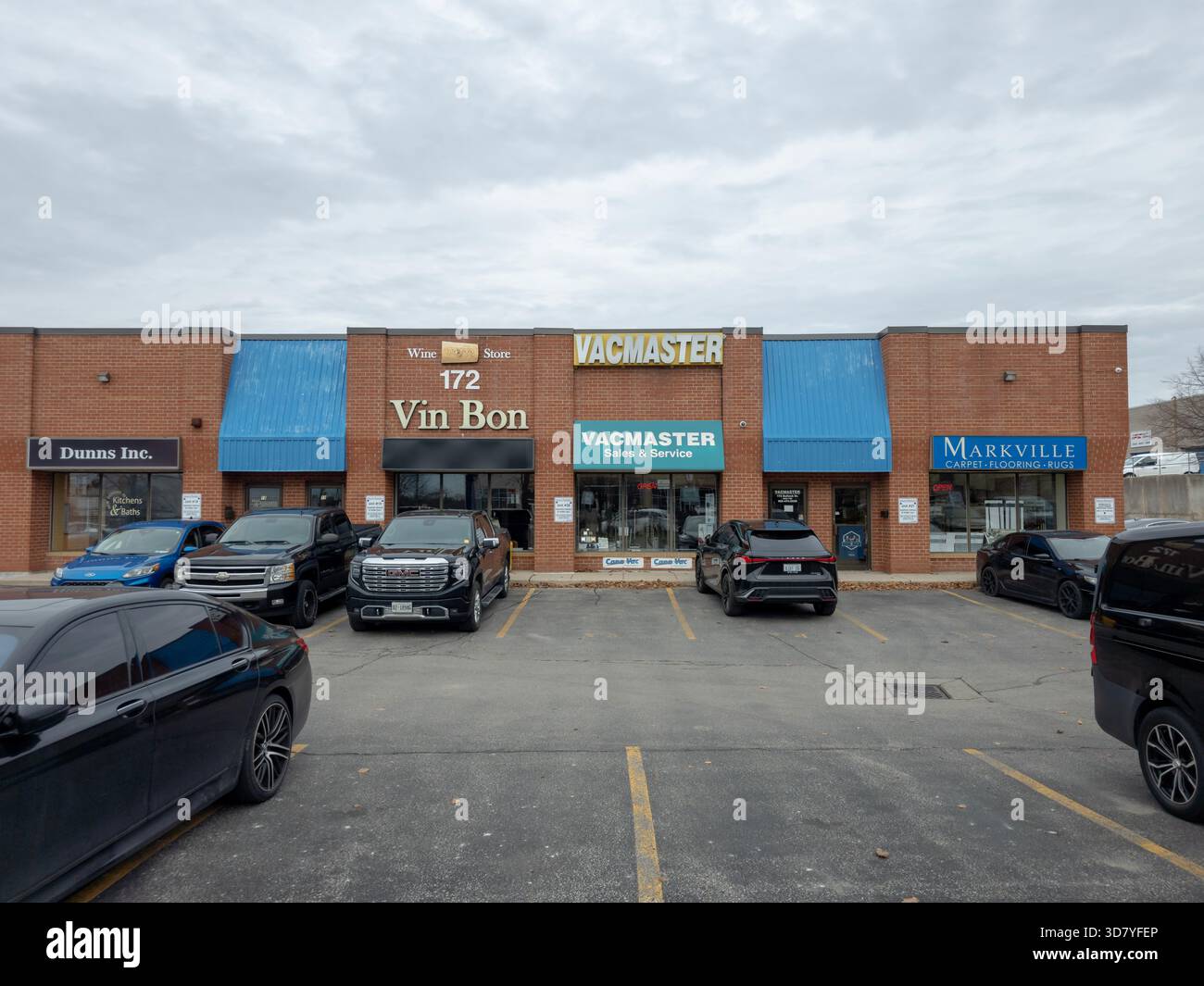 Red brick plaza at 172 Bullock Drive with blue awnings, storefronts ...