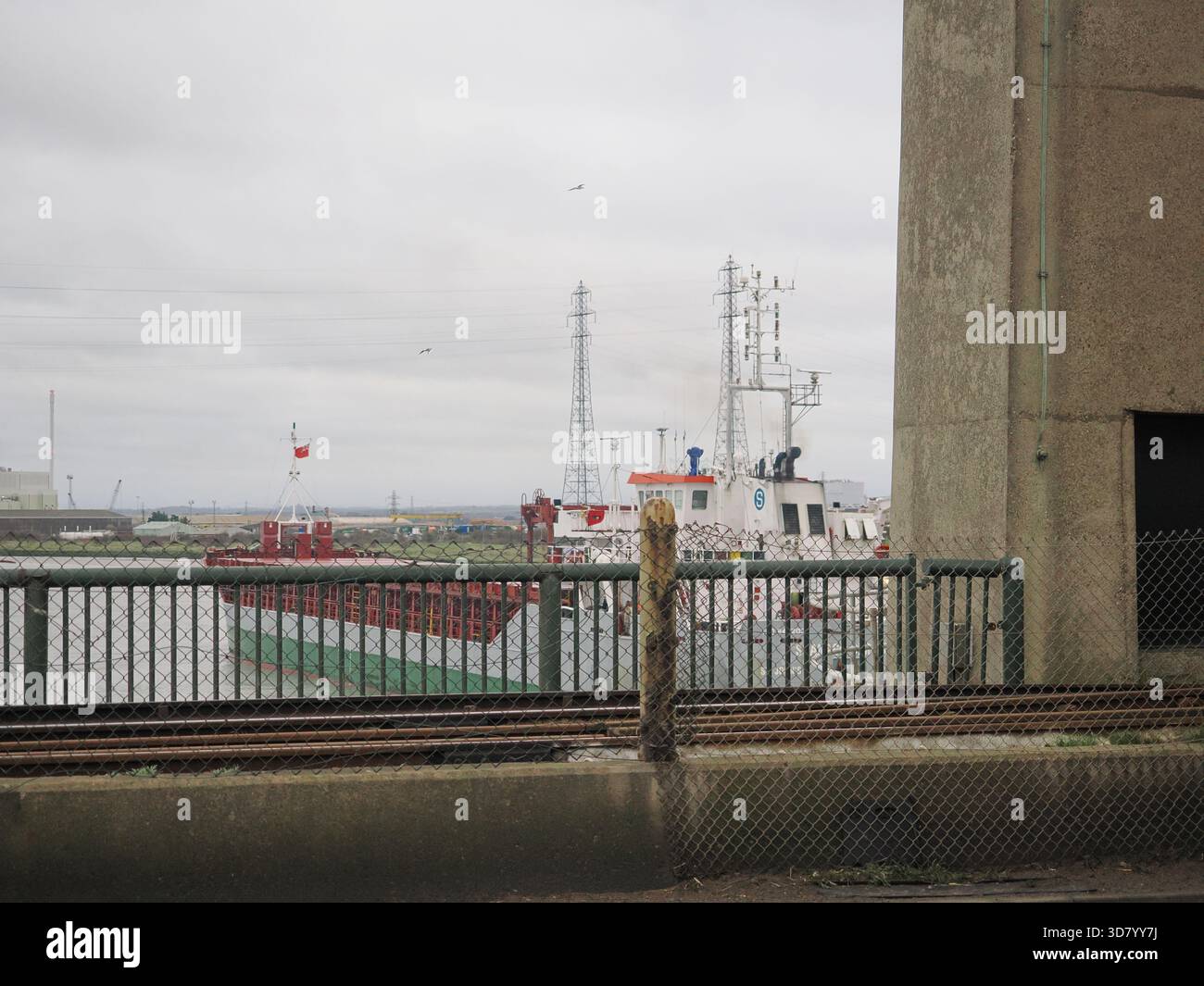 Elmley, Kent, UK. 27th Nov, 2025. Small cargo ship Spanico Simplicity is seen passing under the ...