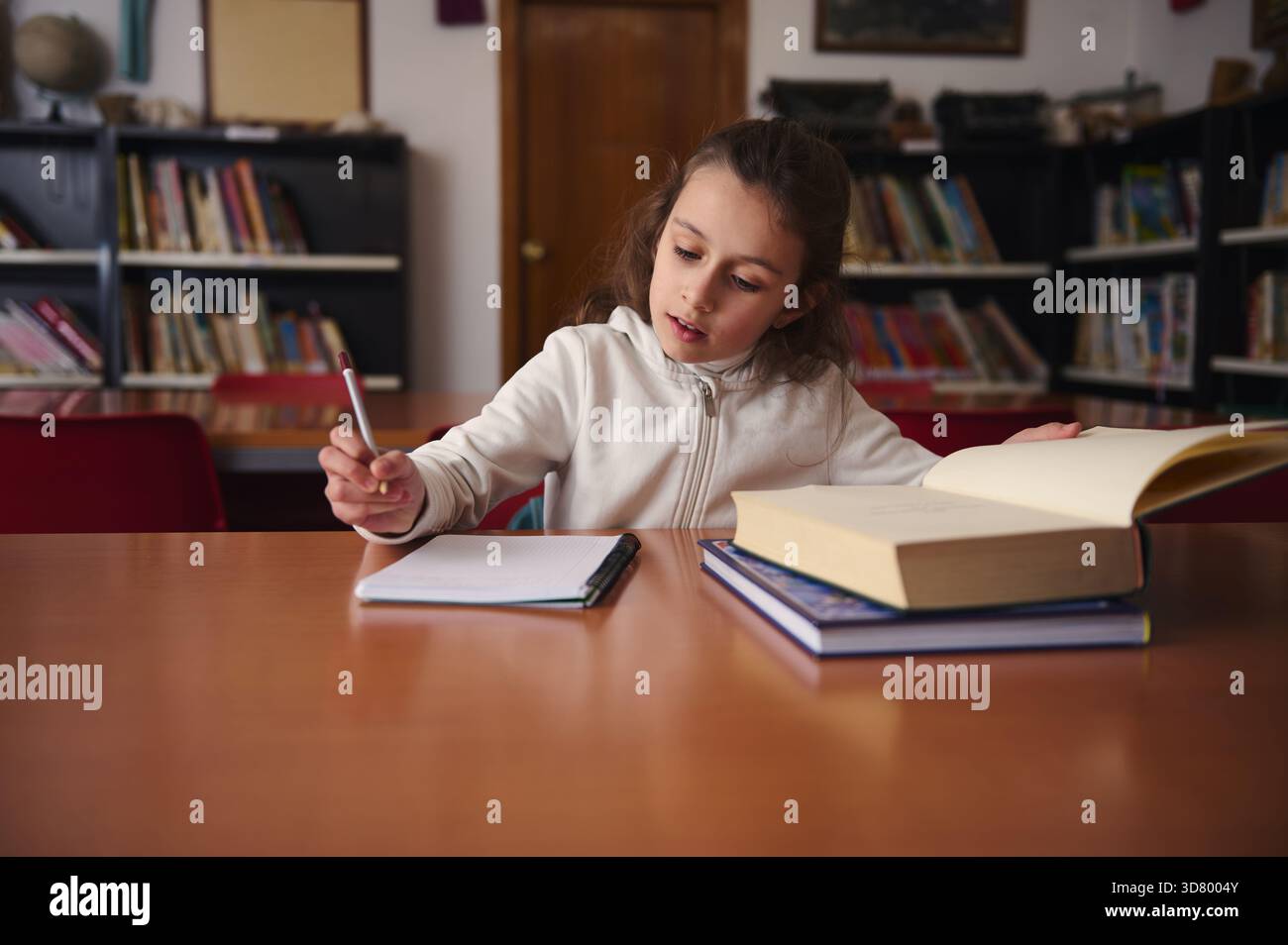 Schoolgirl in library surrounded hi-res stock photography and images ...