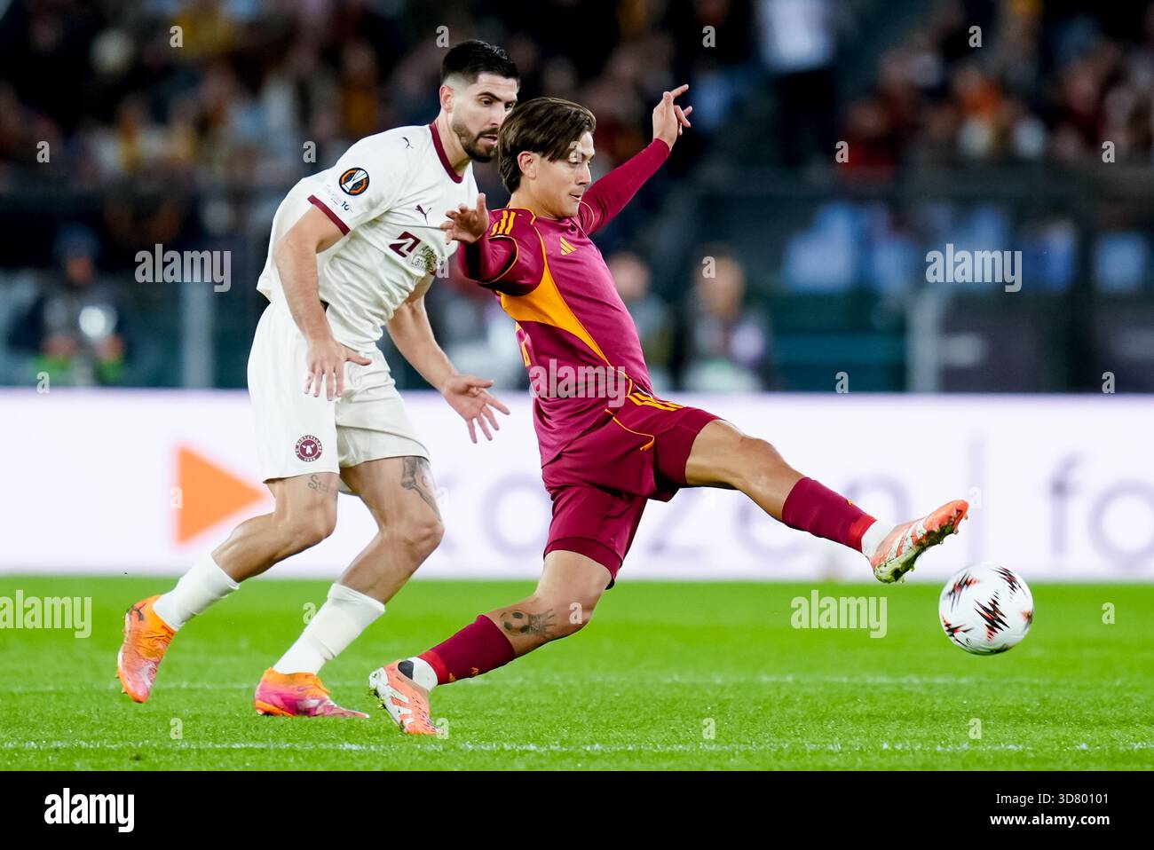 Martin Erlic of FC Midtjylland and Paulo Dybala of AS Roma compete for ...