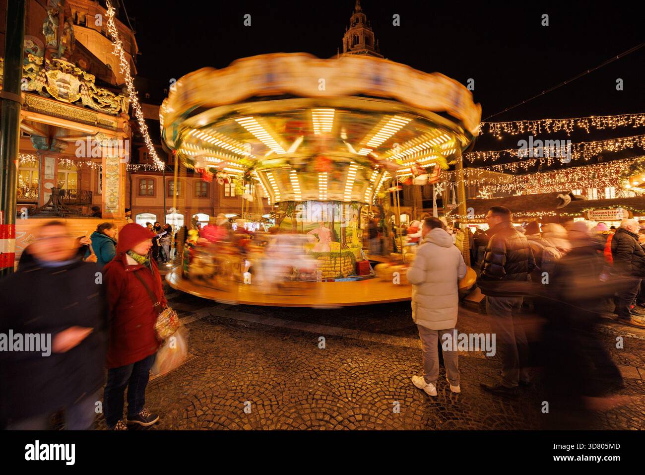 Children are comfortably spinning on a traditional carousel. In the ...