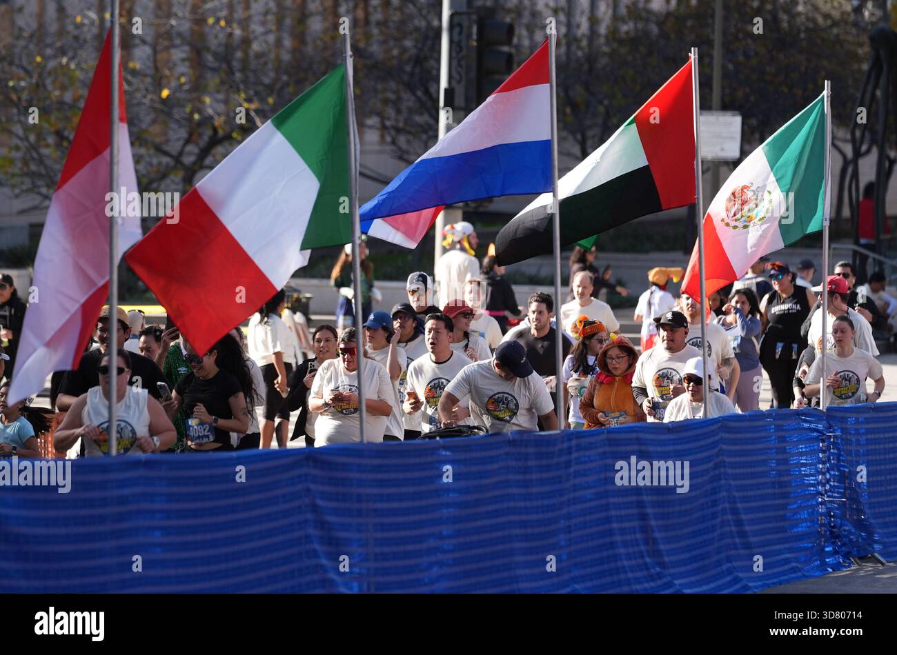 Runners arrive the finish area of the Turkey Trot LA 2025, a fundraiser race for The Midnight ...
