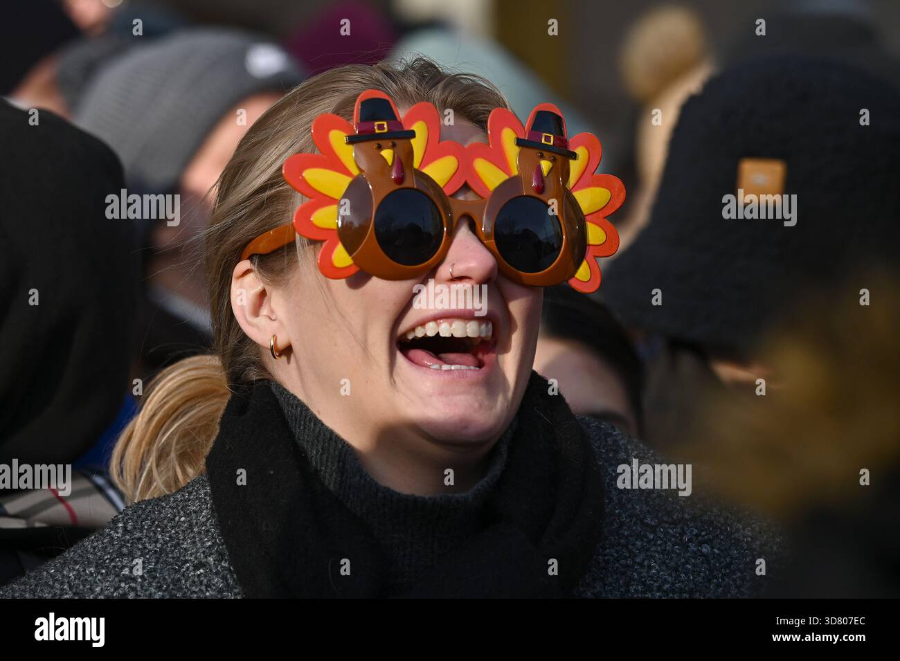 A spectator wears 'turkey sunglasses' standing along Central Park West ...