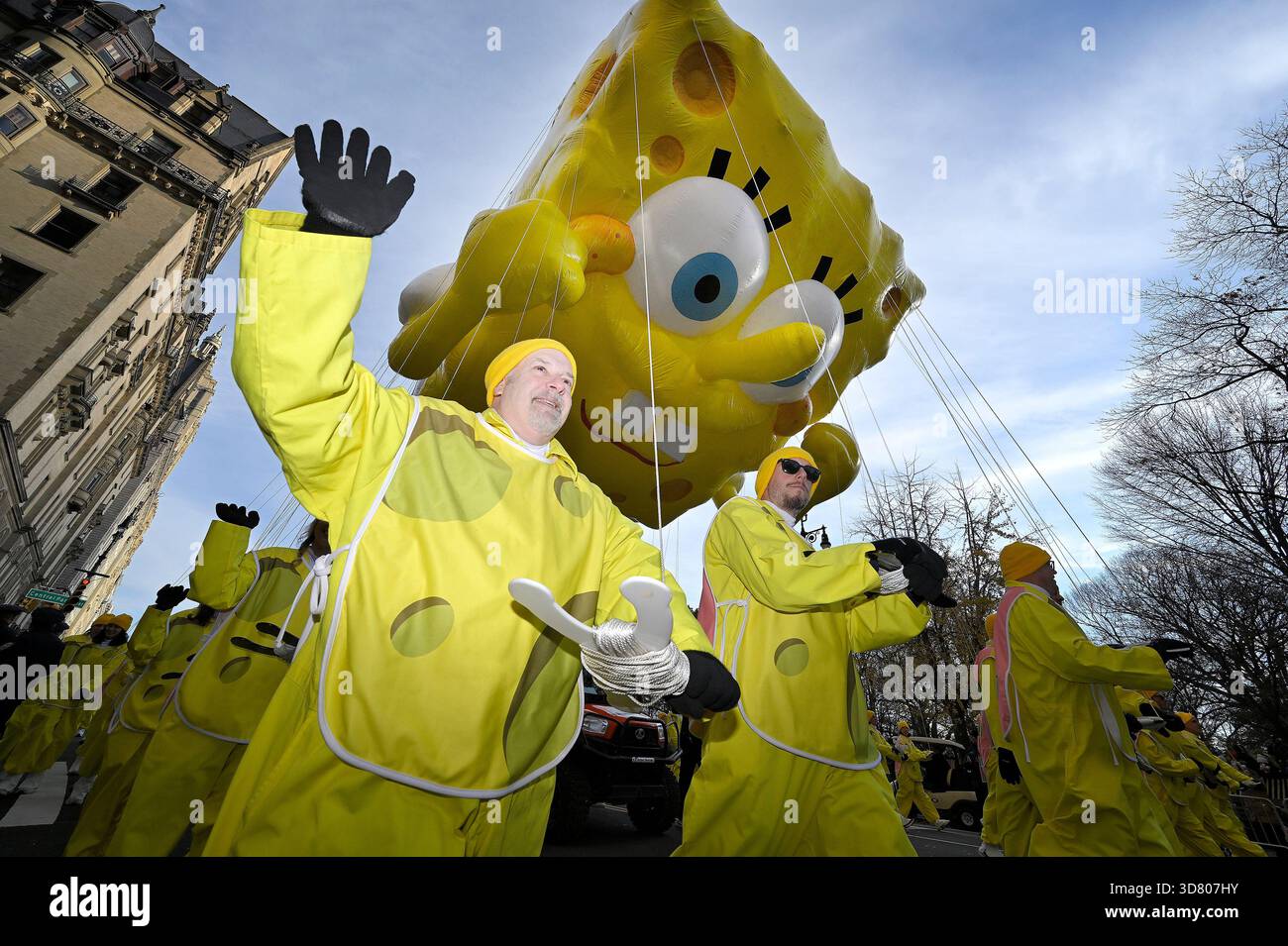 Handlers guide the SpongeBob SquarePants balloon makes its way down ...
