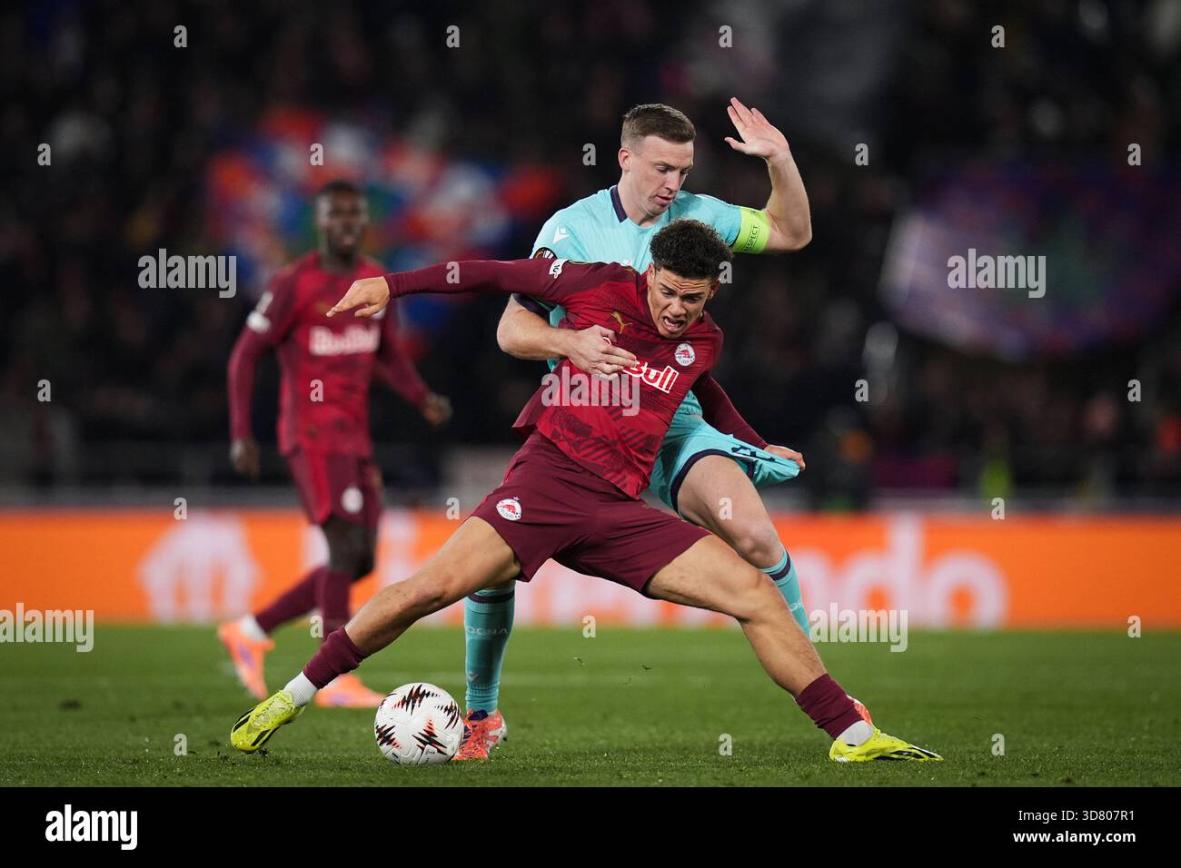 Salzburg's Clement Bischoff, front, and Bologna's Lewis Ferguson, rear ...